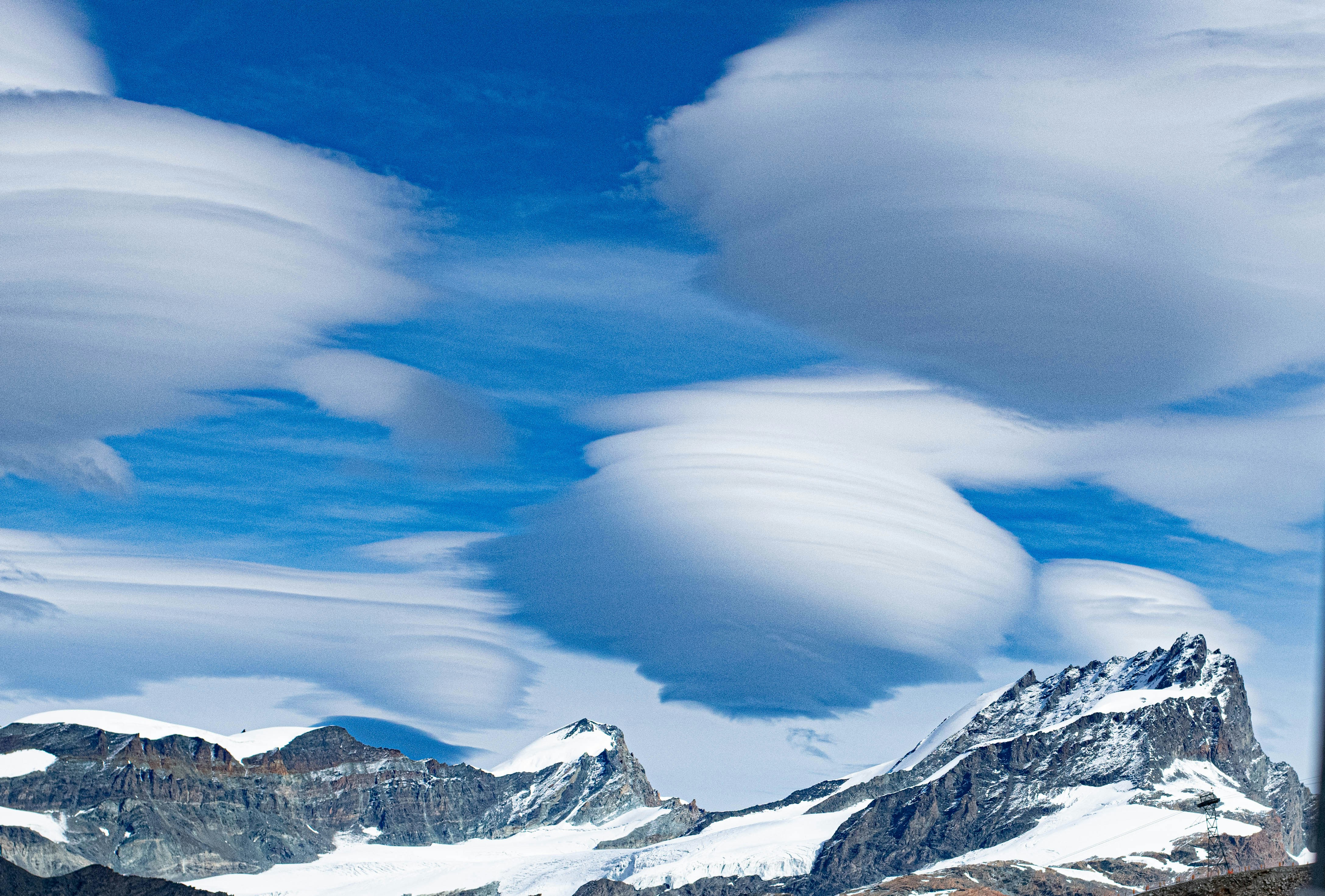 Lenticular Ballet Over Alpine Ridges
