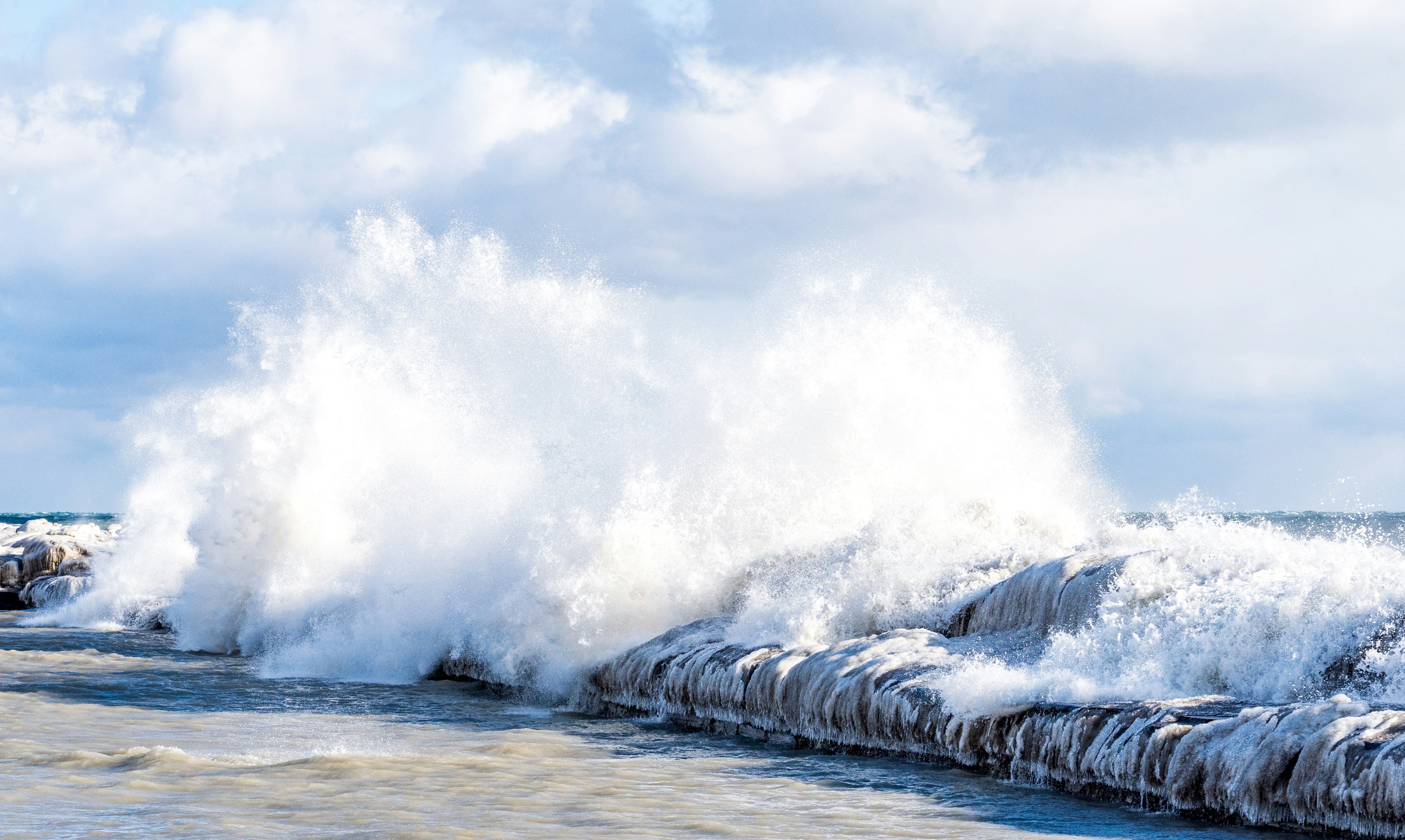 A large wave crashing over a break wall photo – Free Nature Image on ...