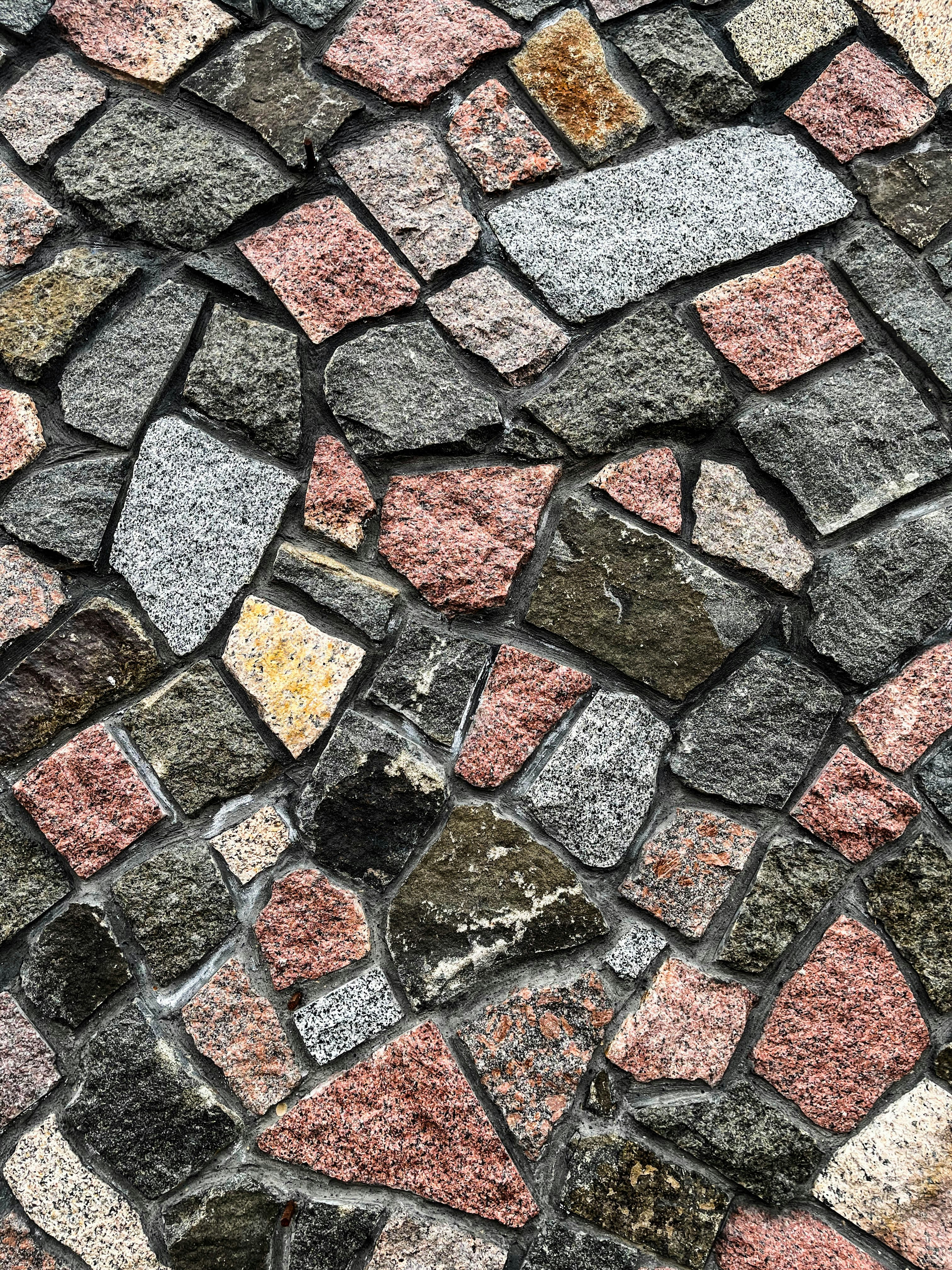 Foto Un primer plano de un muro de piedra hecho de pequeñas rocas ...