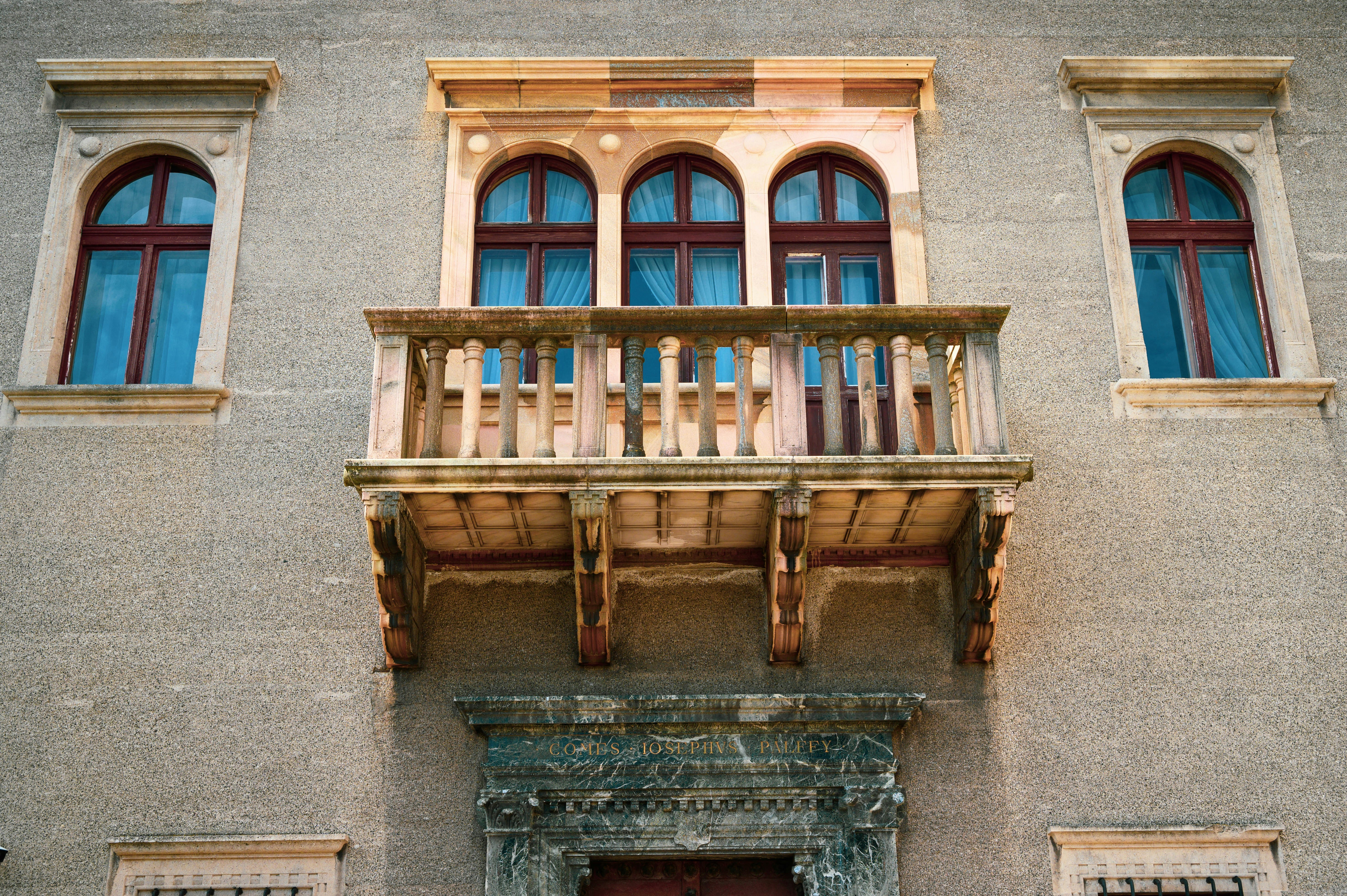 Timeworn Balcony Framing a Quiet Facade