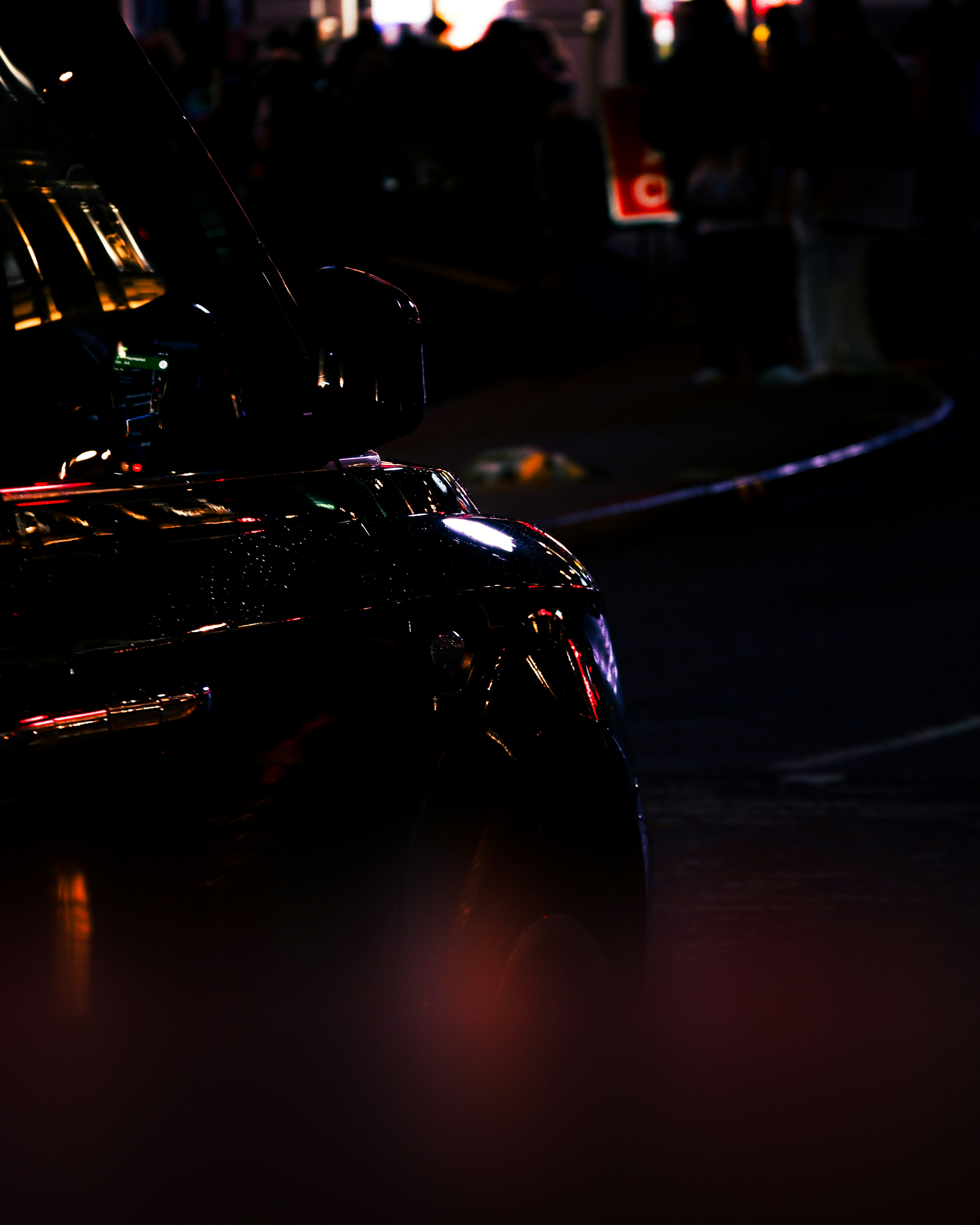 a car parked on the side of the road at night
