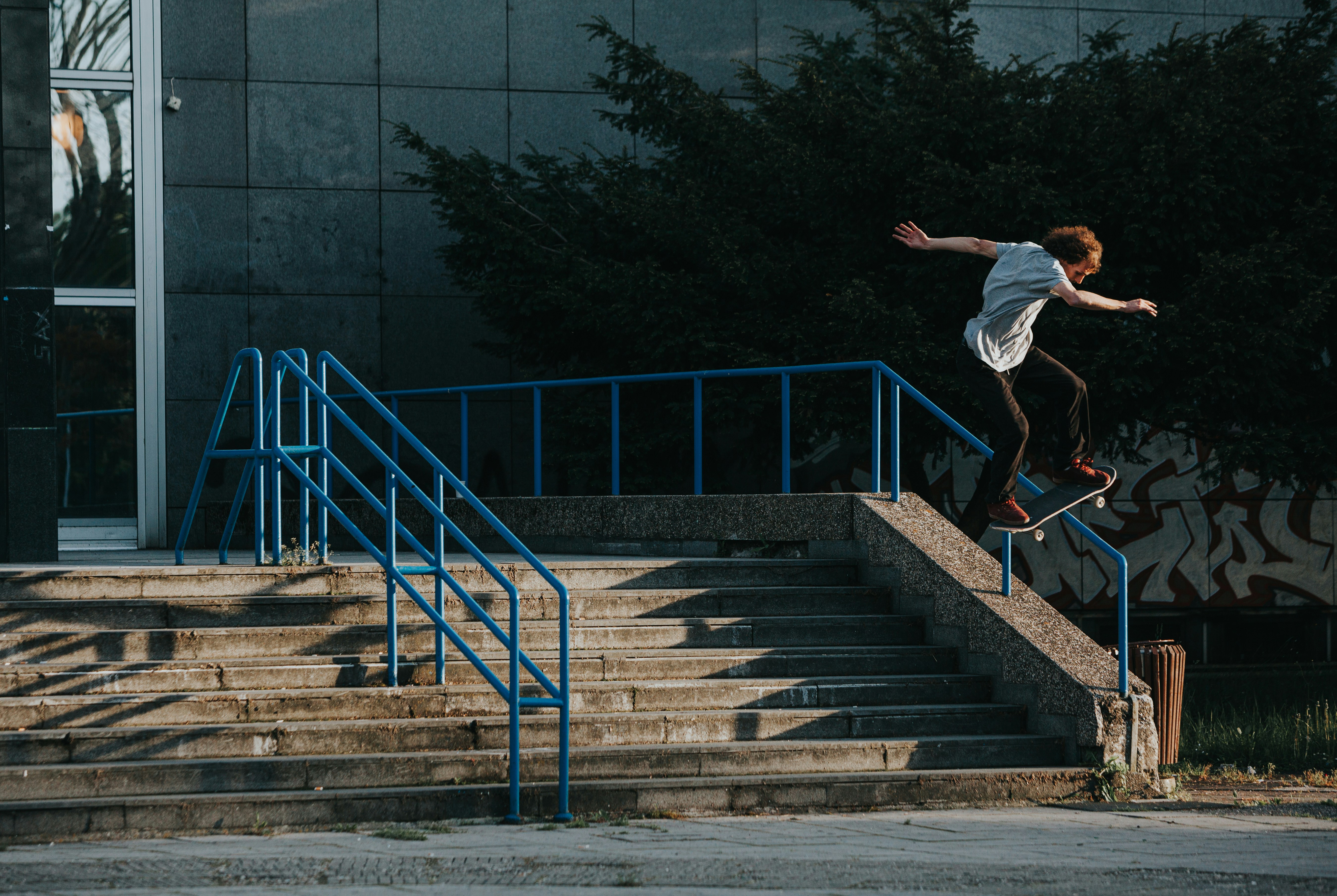 A man riding a skateboard down the side of a flight of stairs photo ...