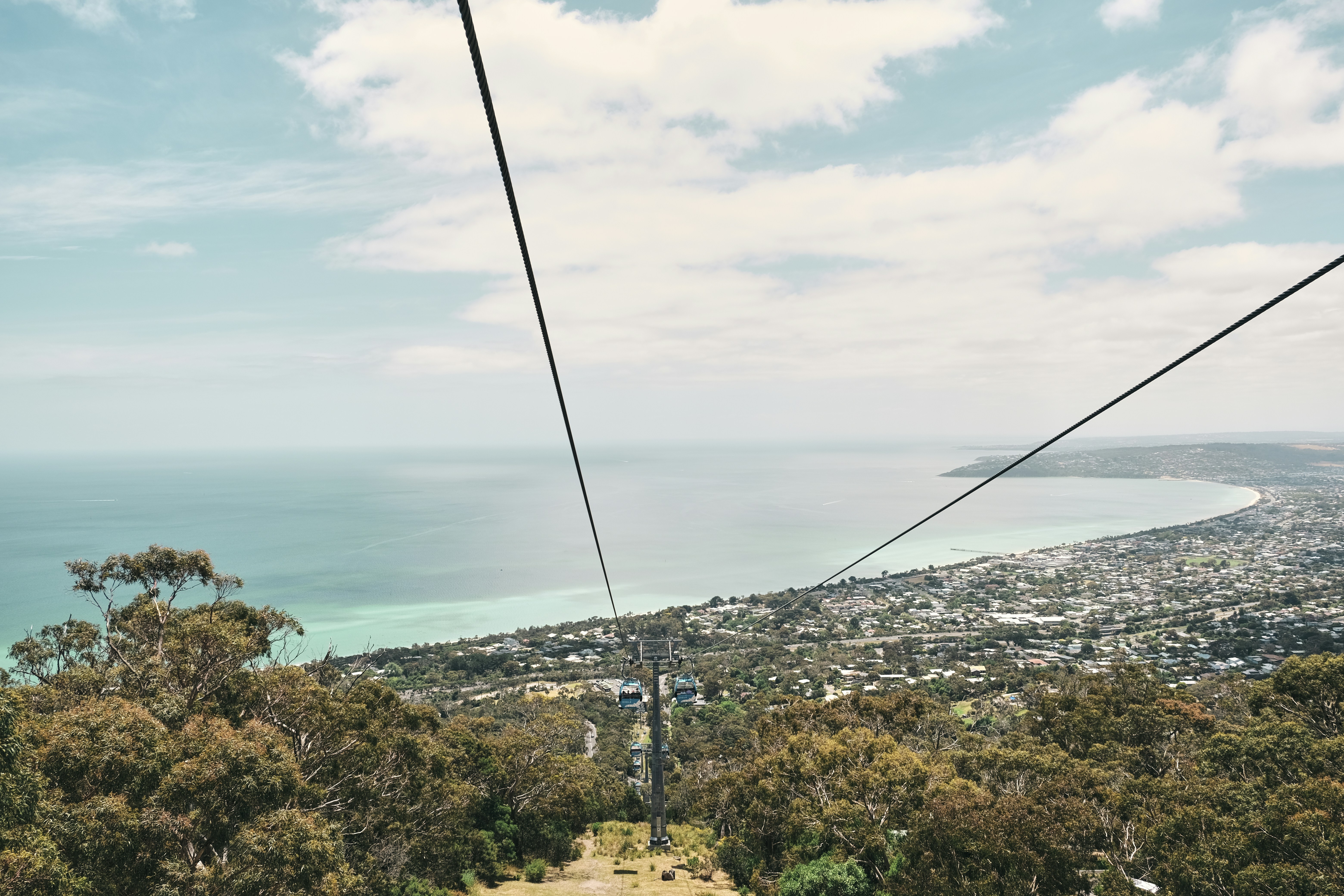 Threaded Horizons: Cable Lines Framing a Coastal Hilltown