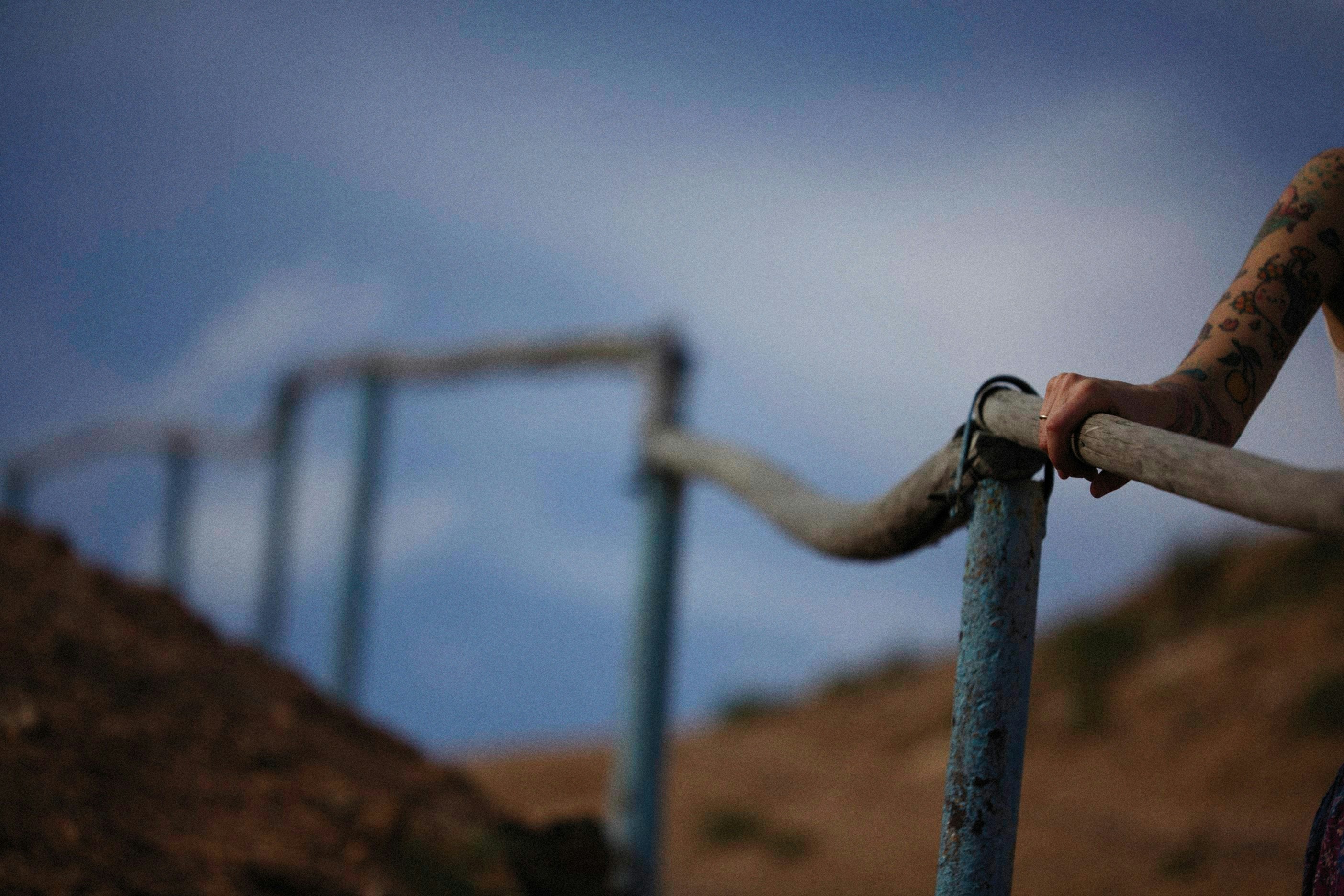Rusted Railings on a Distant Slope