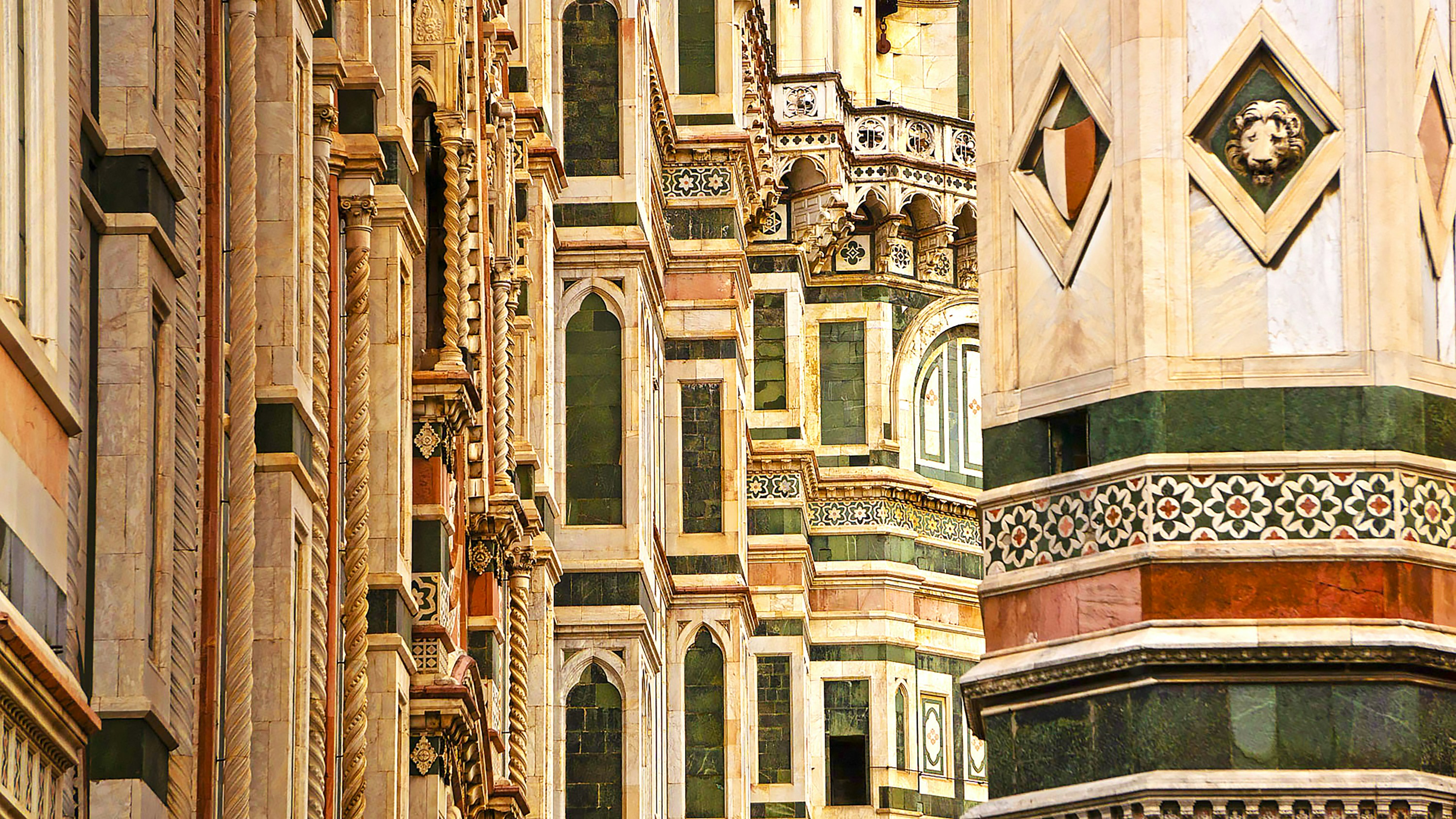 Detailed view of ornate architectural elements in Florence, showcasing intricate stonework and decorative patterns.