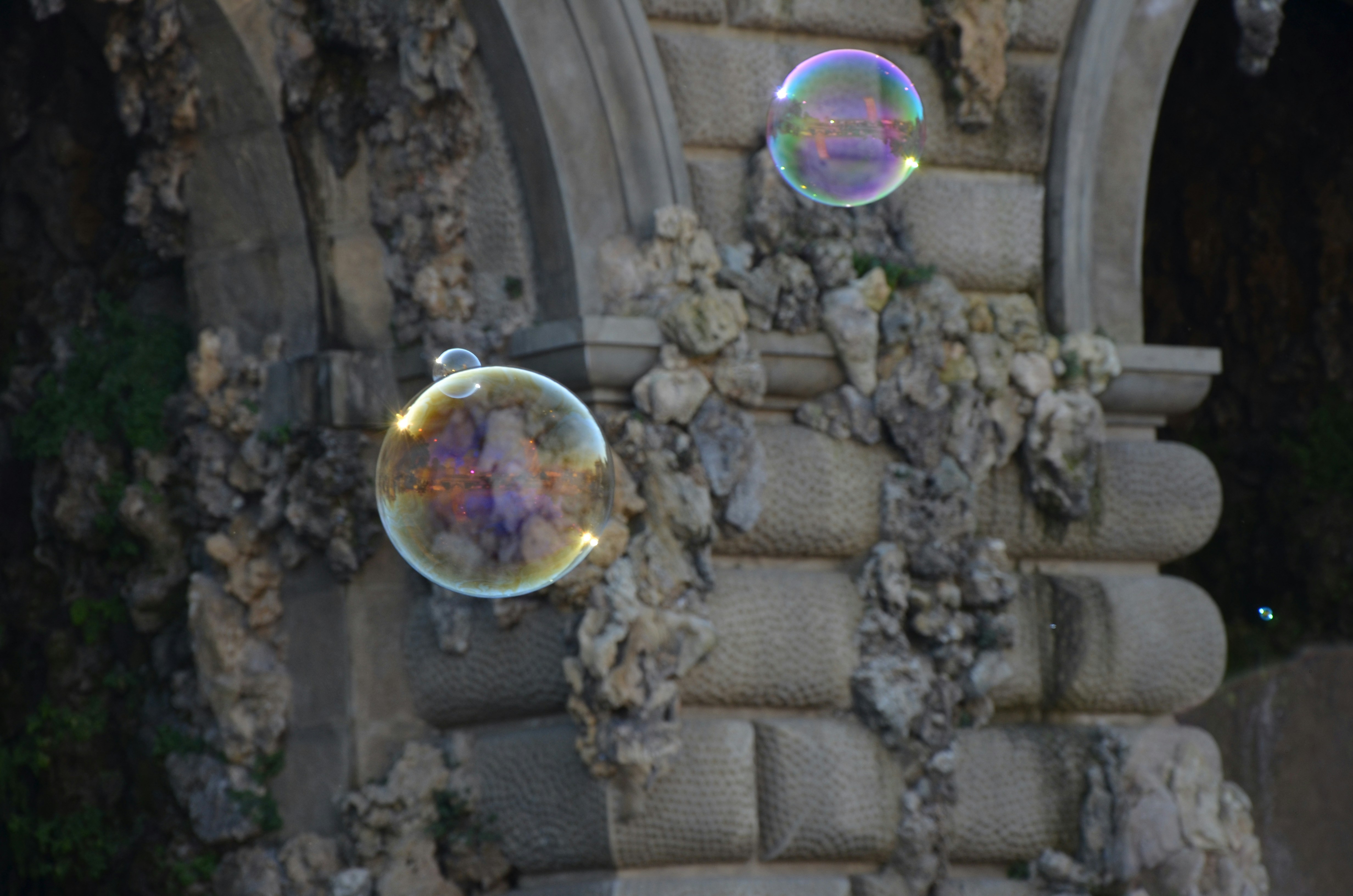 Soap bubbles floating in front of a stone building photo – Free Italy ...