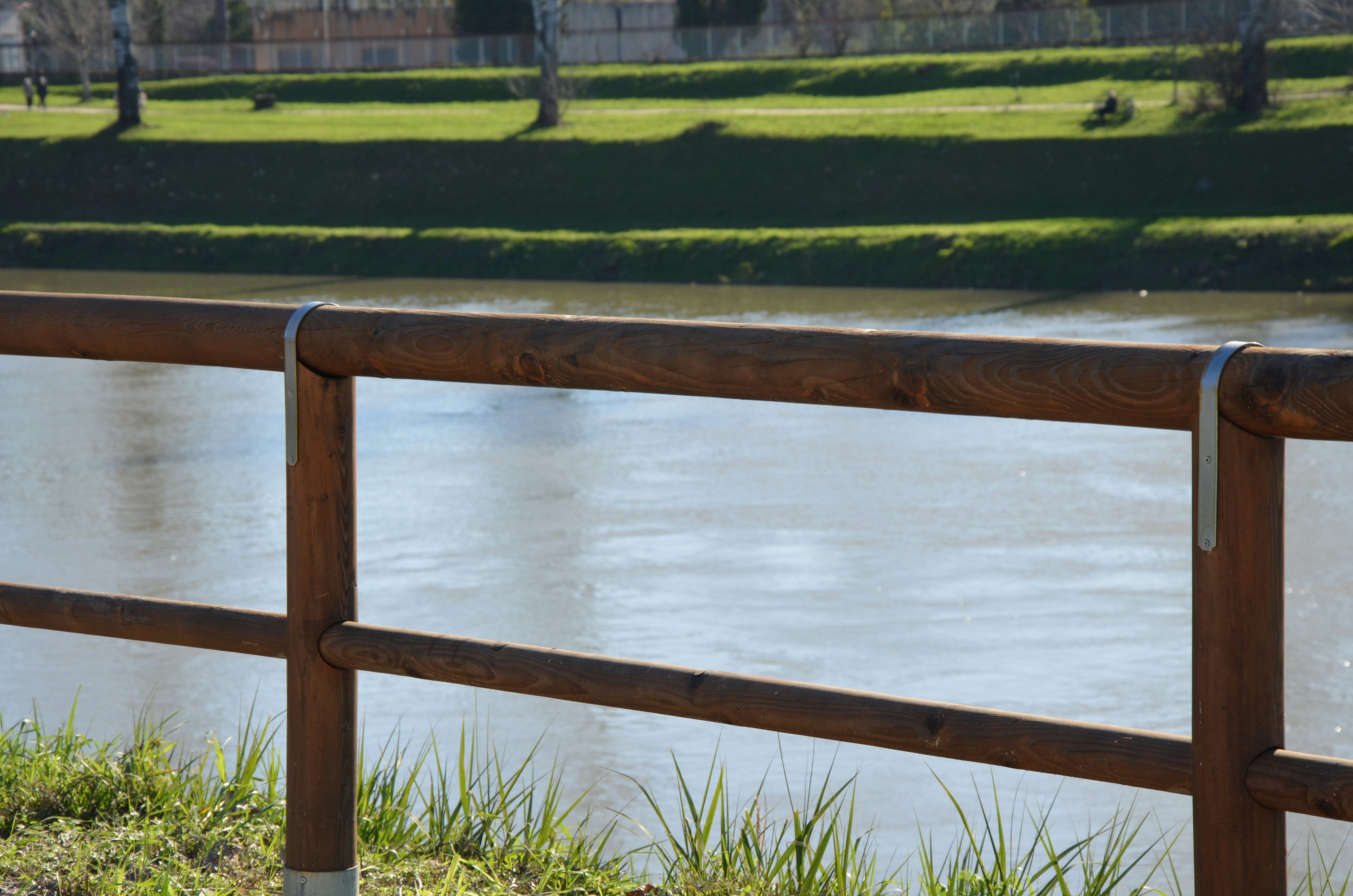 a wooden fence next to a body of water