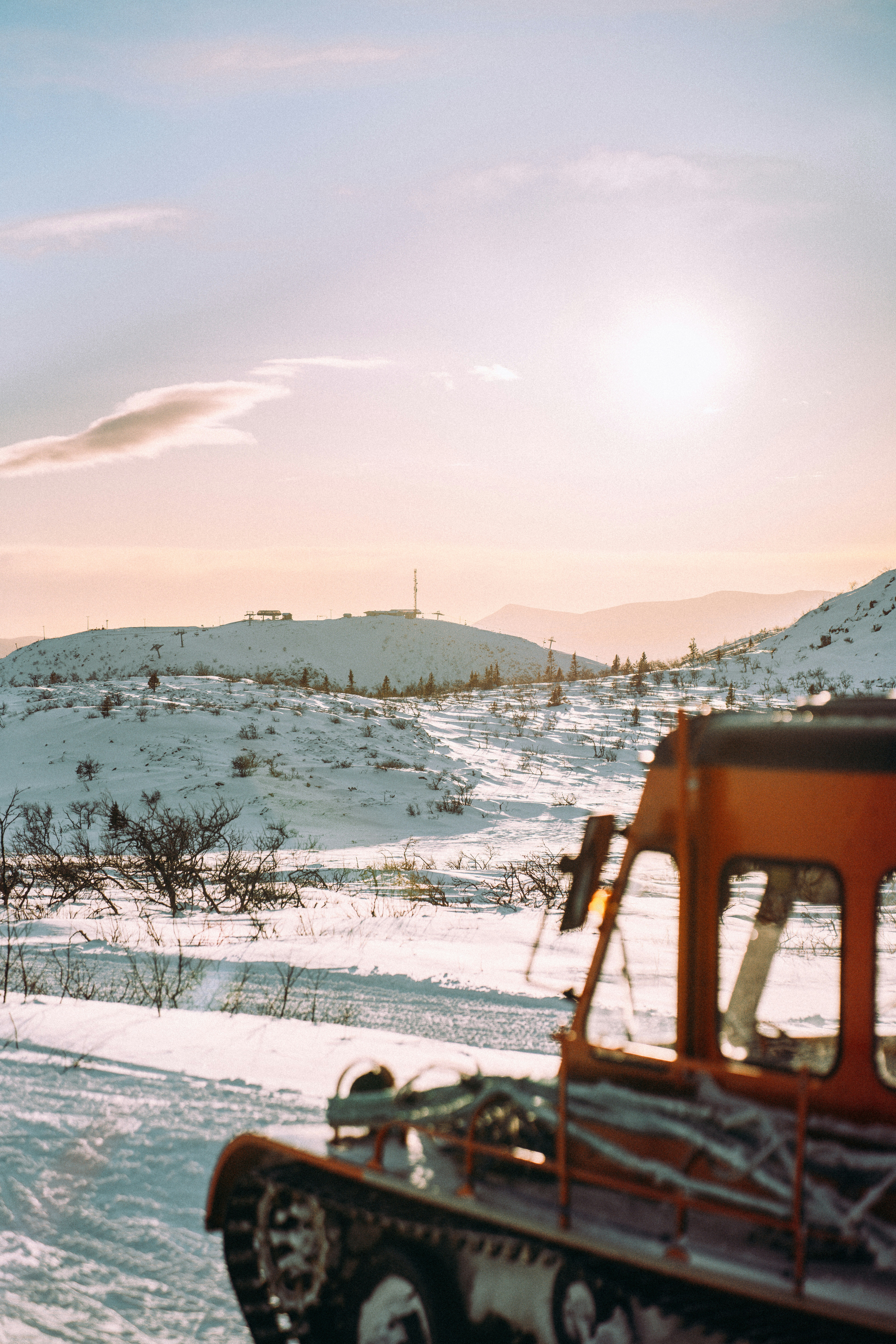 Sunrise over the Rusted Tracker: Snowfield and a Weathered Machine