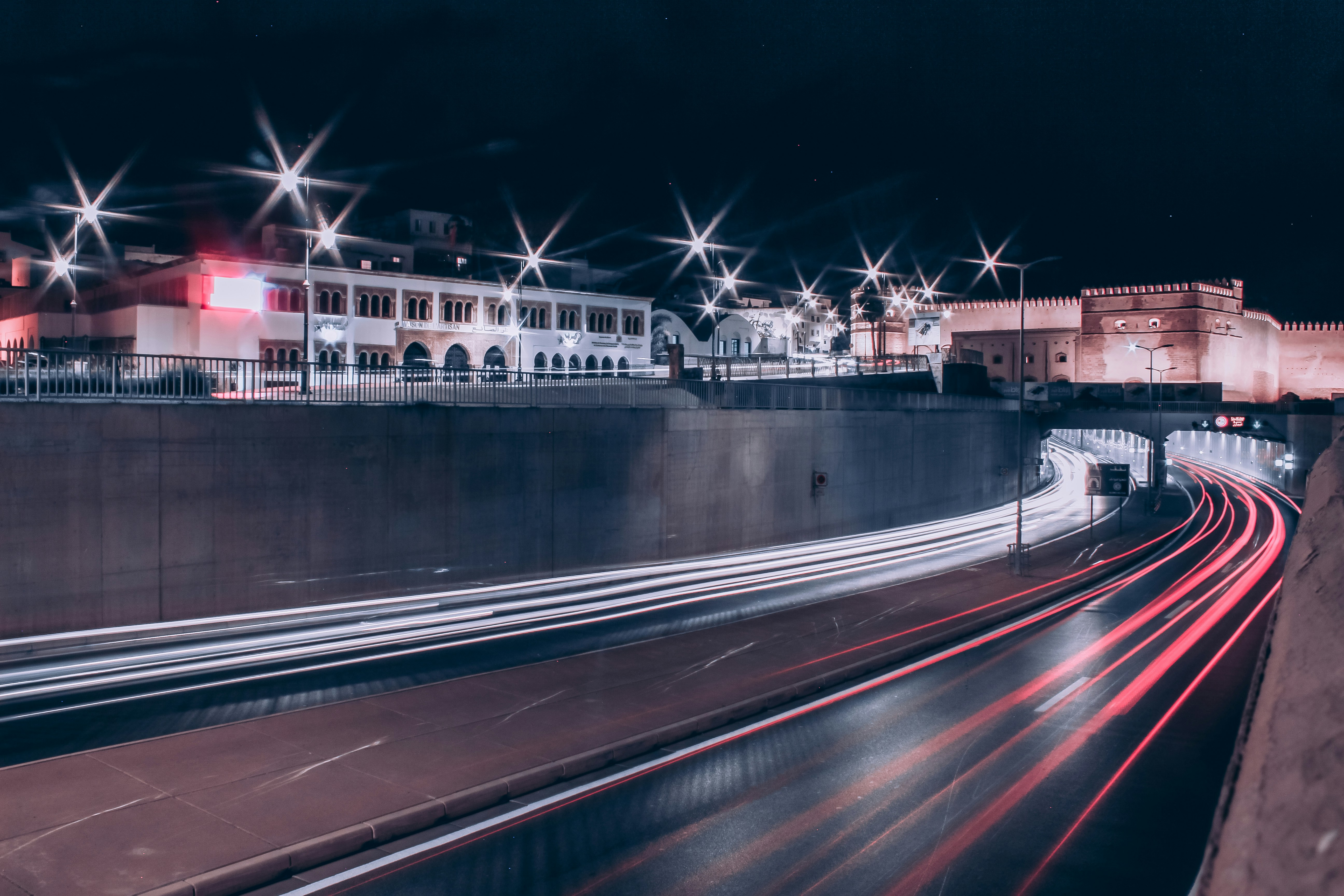 Night Run: Neon Light Trails Curling Over a City Waterfront