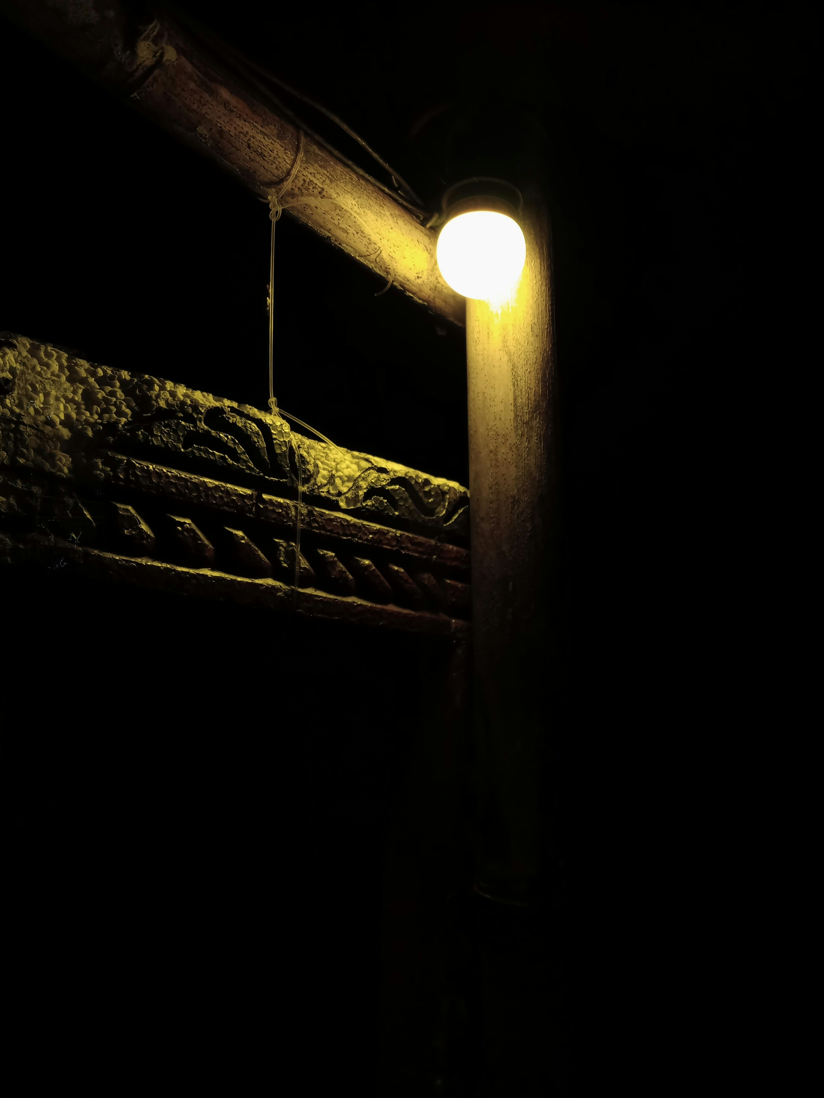 Single Lantern, Silent Carved Beam: Nighttime Illumination on Timber and Relief