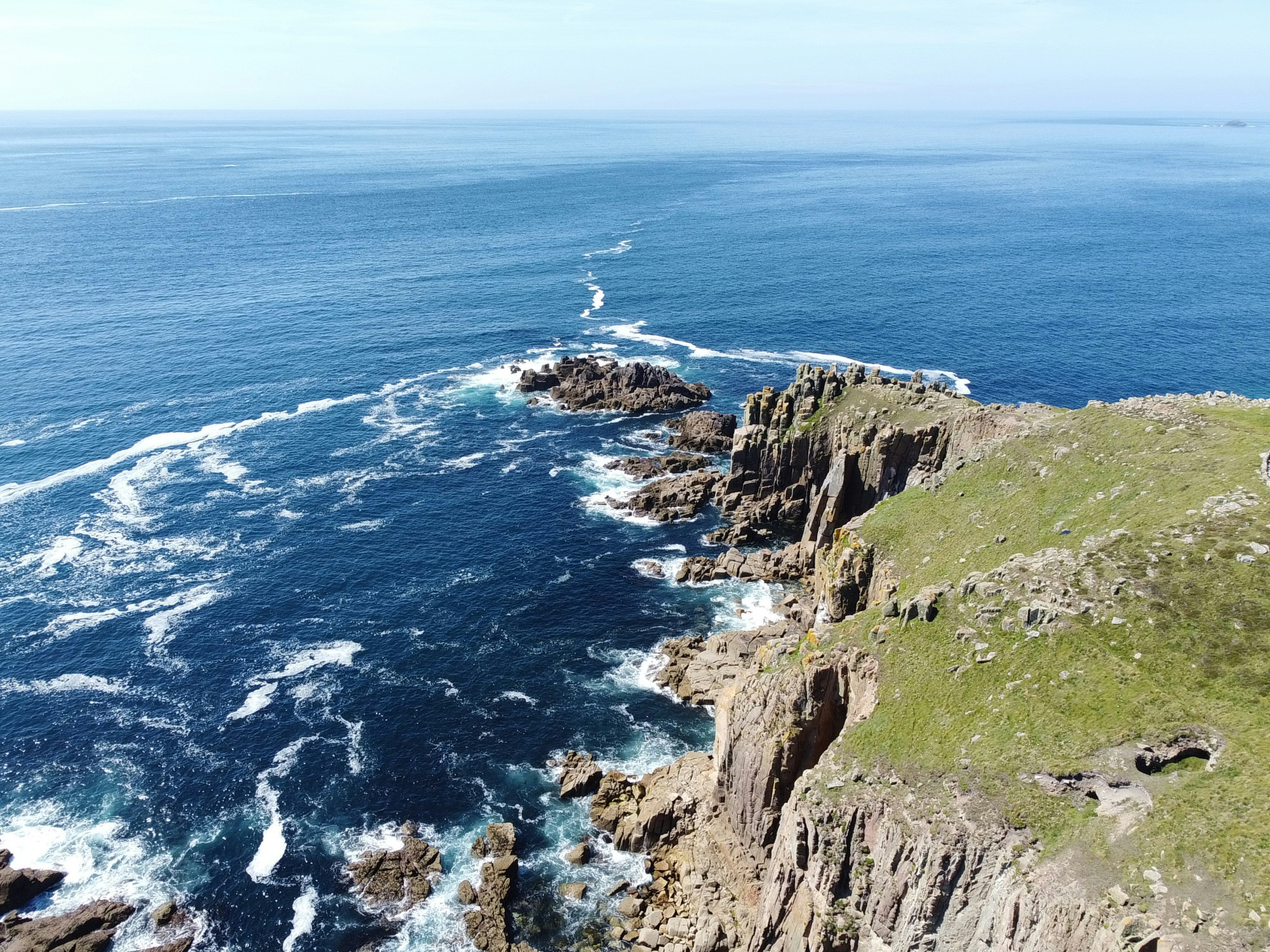 A view of the ocean from the top of a cliff photo – Free Lands end ...