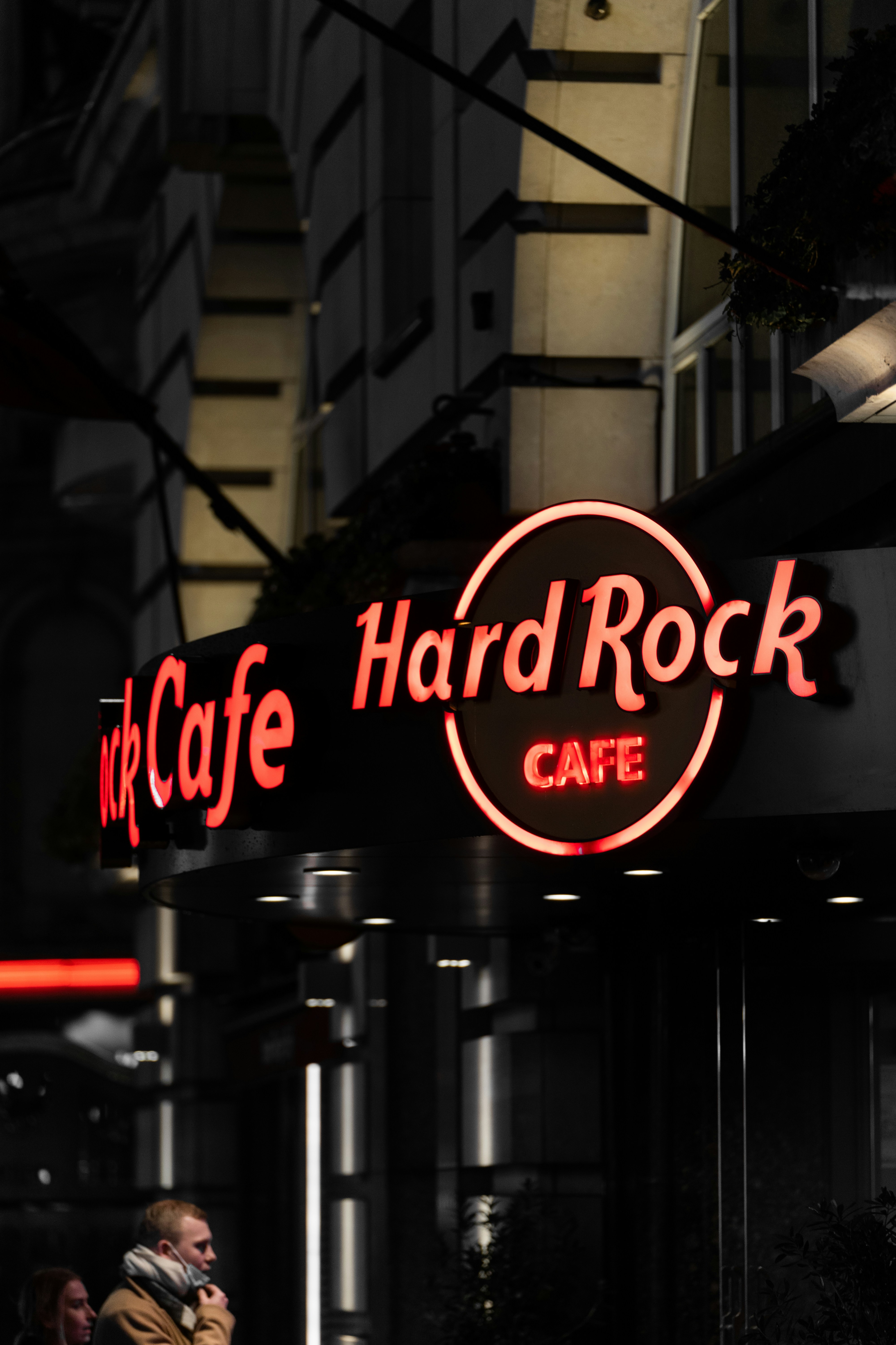 Neon Halo Over the Night Street: Hard Rock Cafe Sign in Red Glow