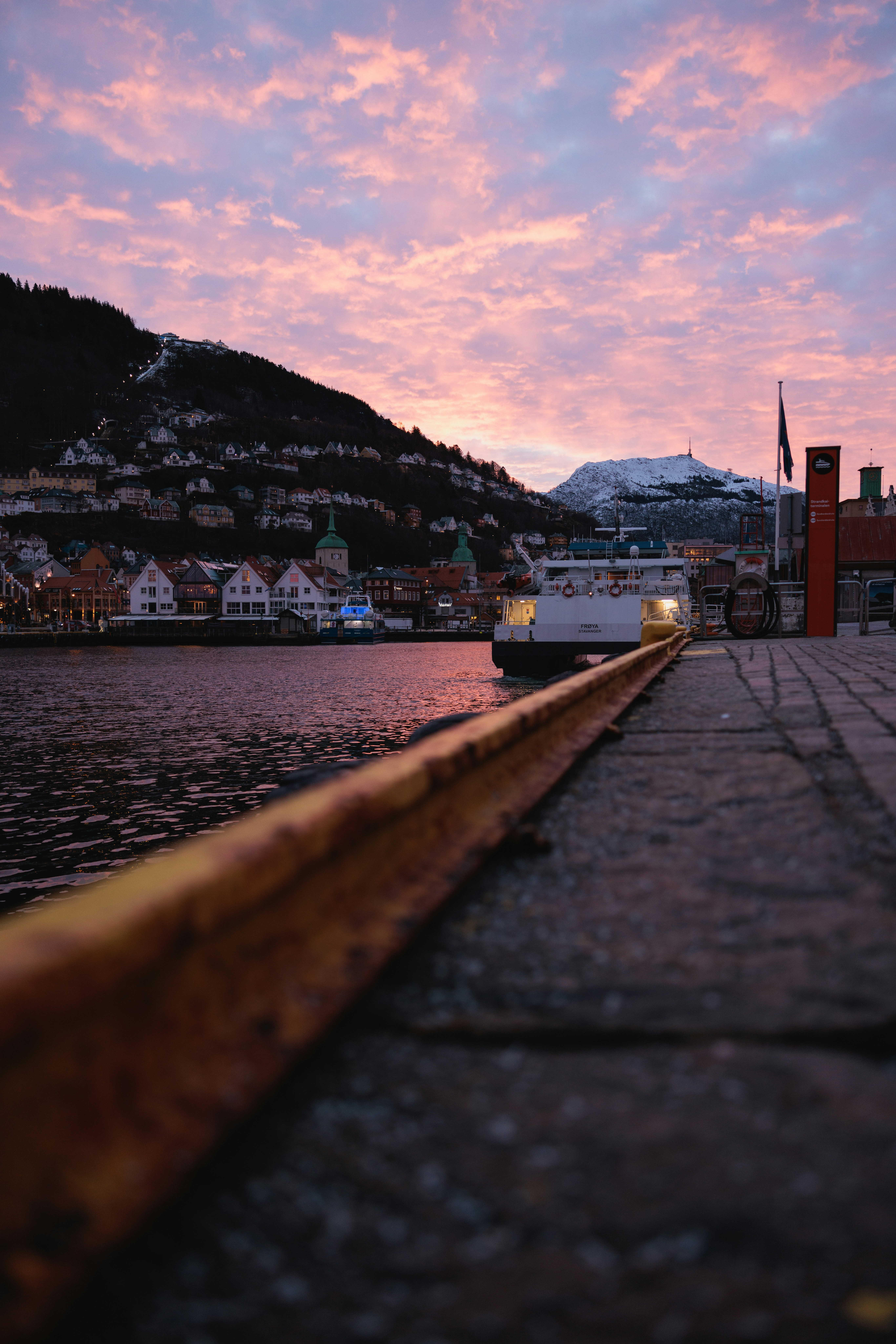 Harbor at Dusk: Pink Clouds Over a Snow-Kissed Village