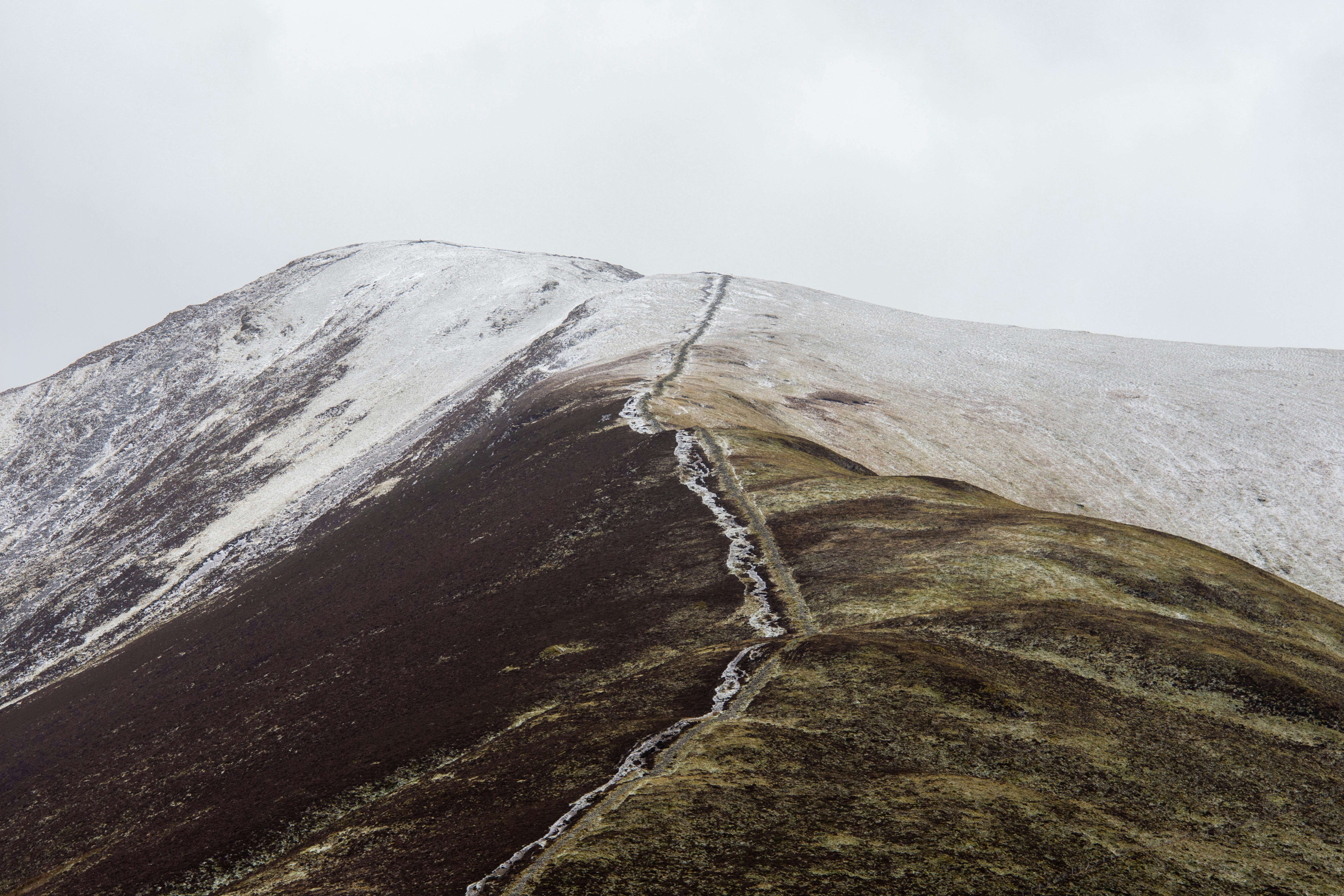 A very tall mountain with a very steep side photo – Free Track Image on ...