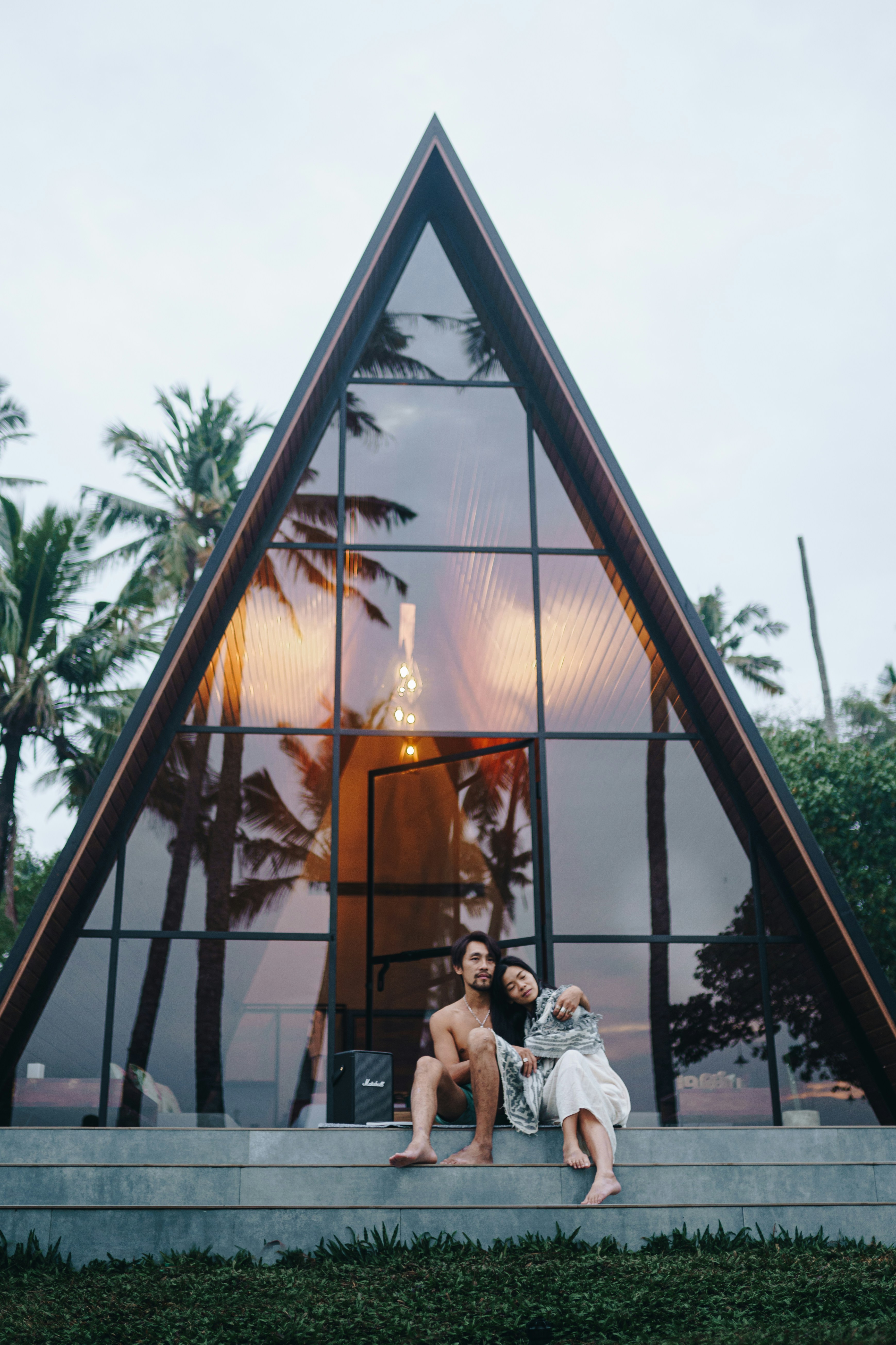 A-Frame Tranquility: Couple at the Glass Chapel's Base