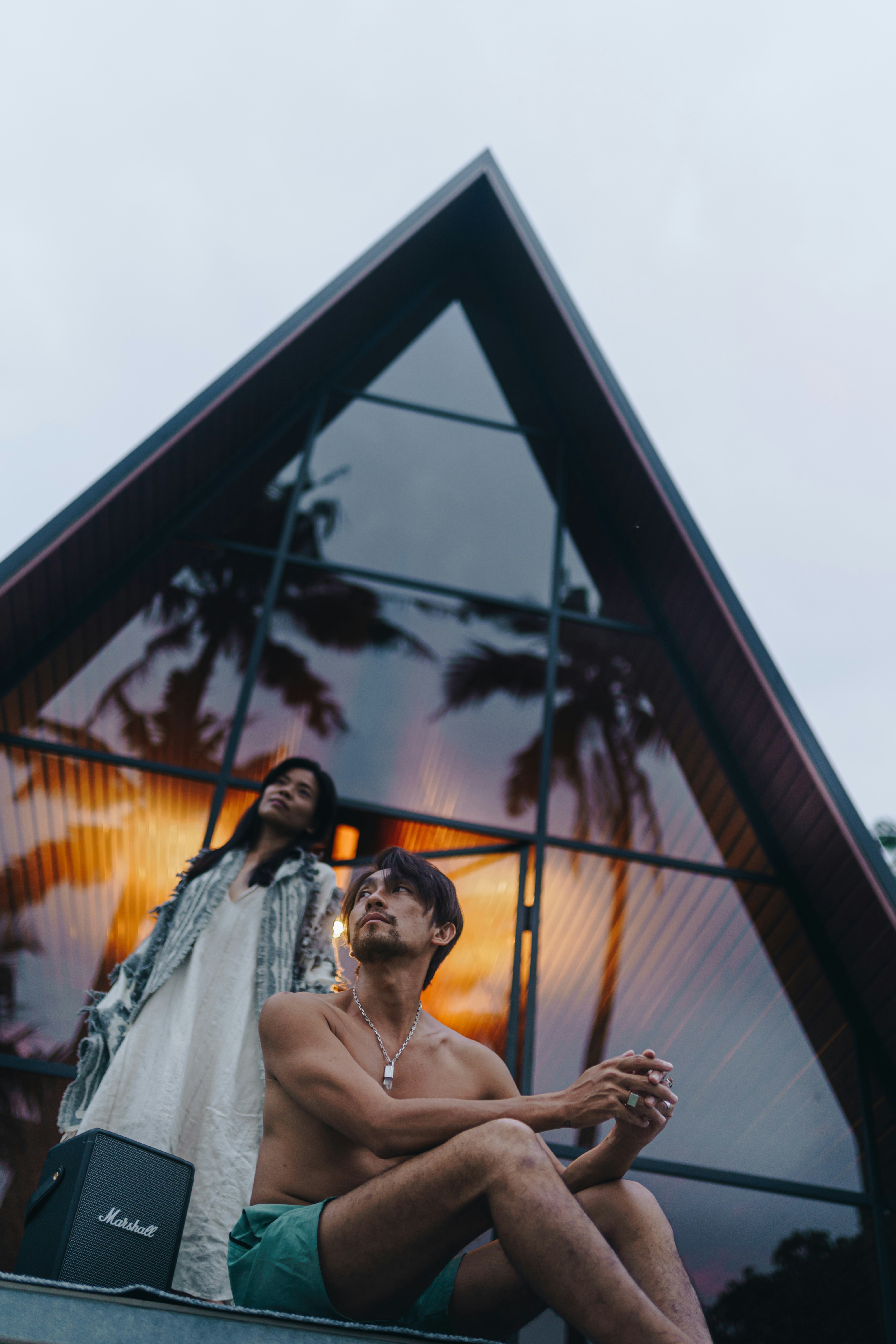 a man and a woman sitting on a roof