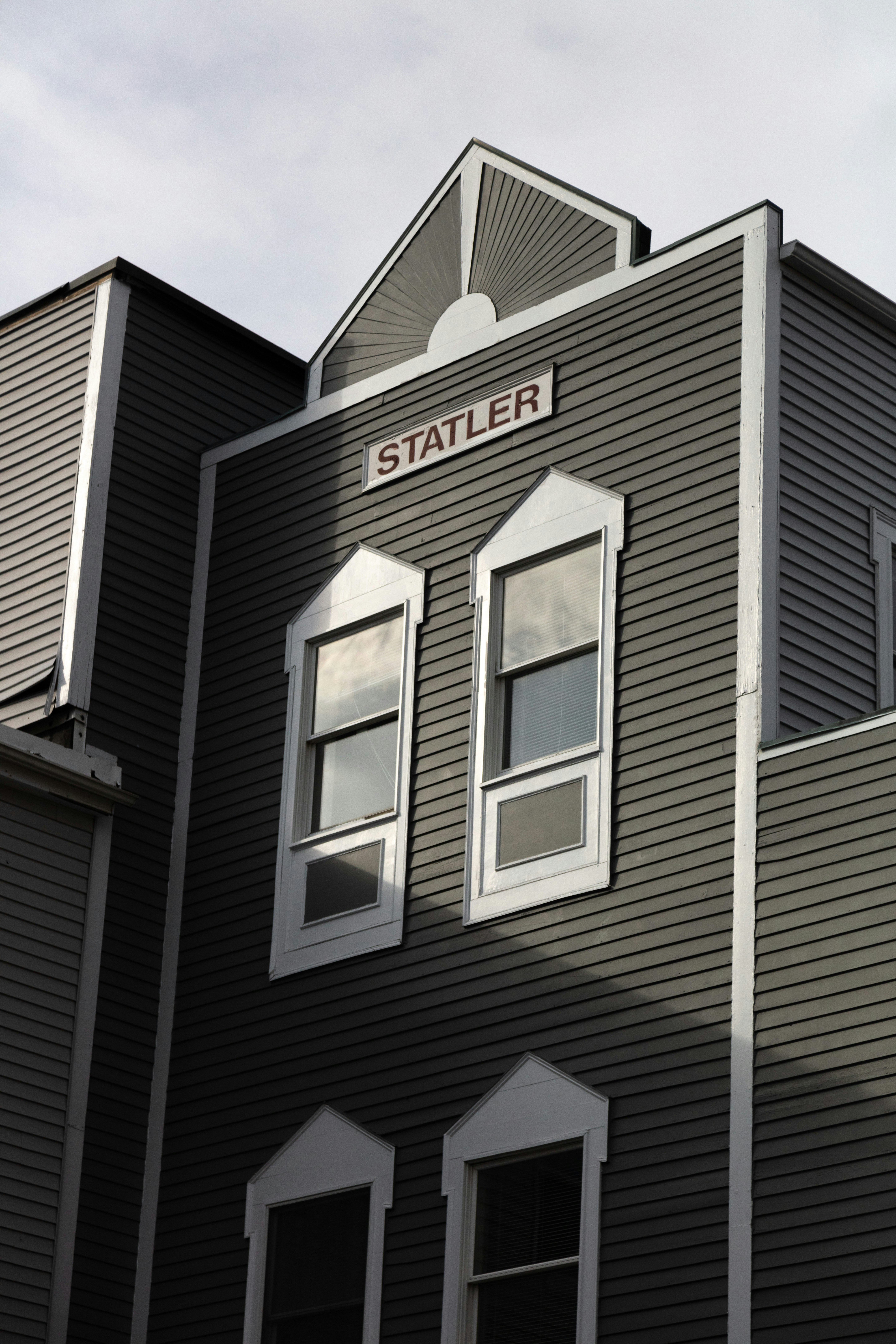 A black building with a red stater sign on it photo – Free City Image ...
