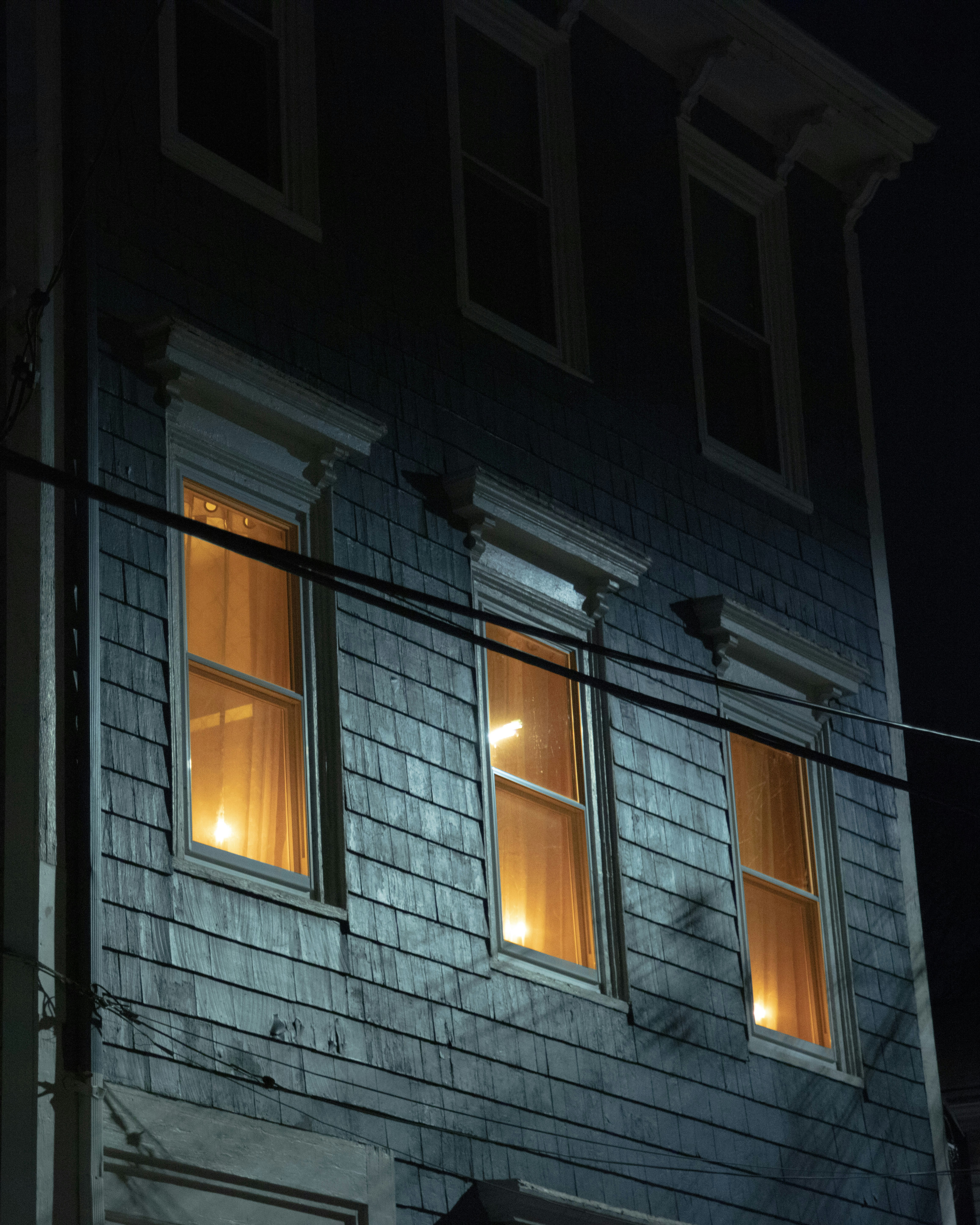 A building with three windows lit up at night photo – Free Usa Image on ...