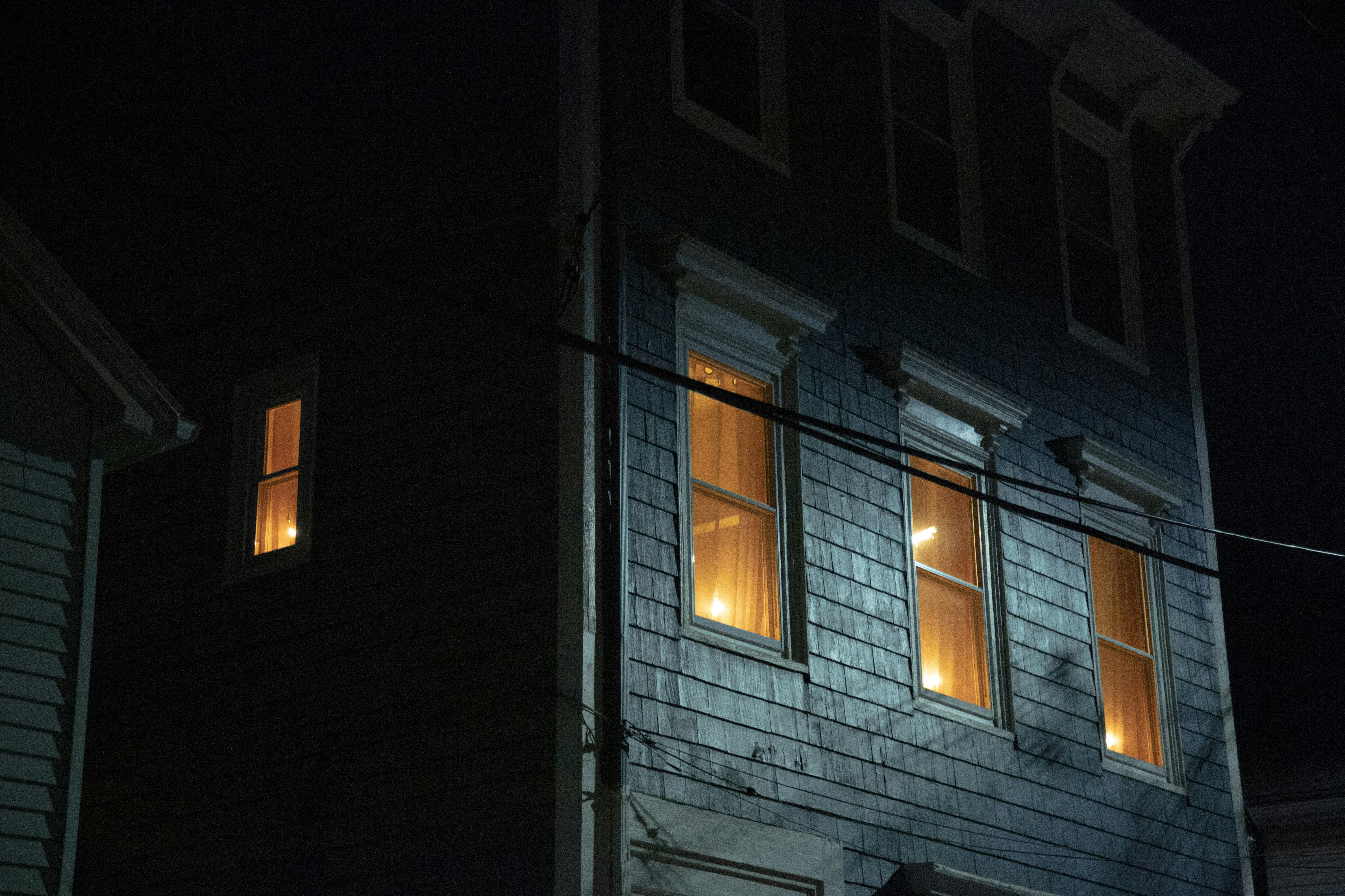 A house with two windows lit up at night photo – Free Usa Image on Unsplash