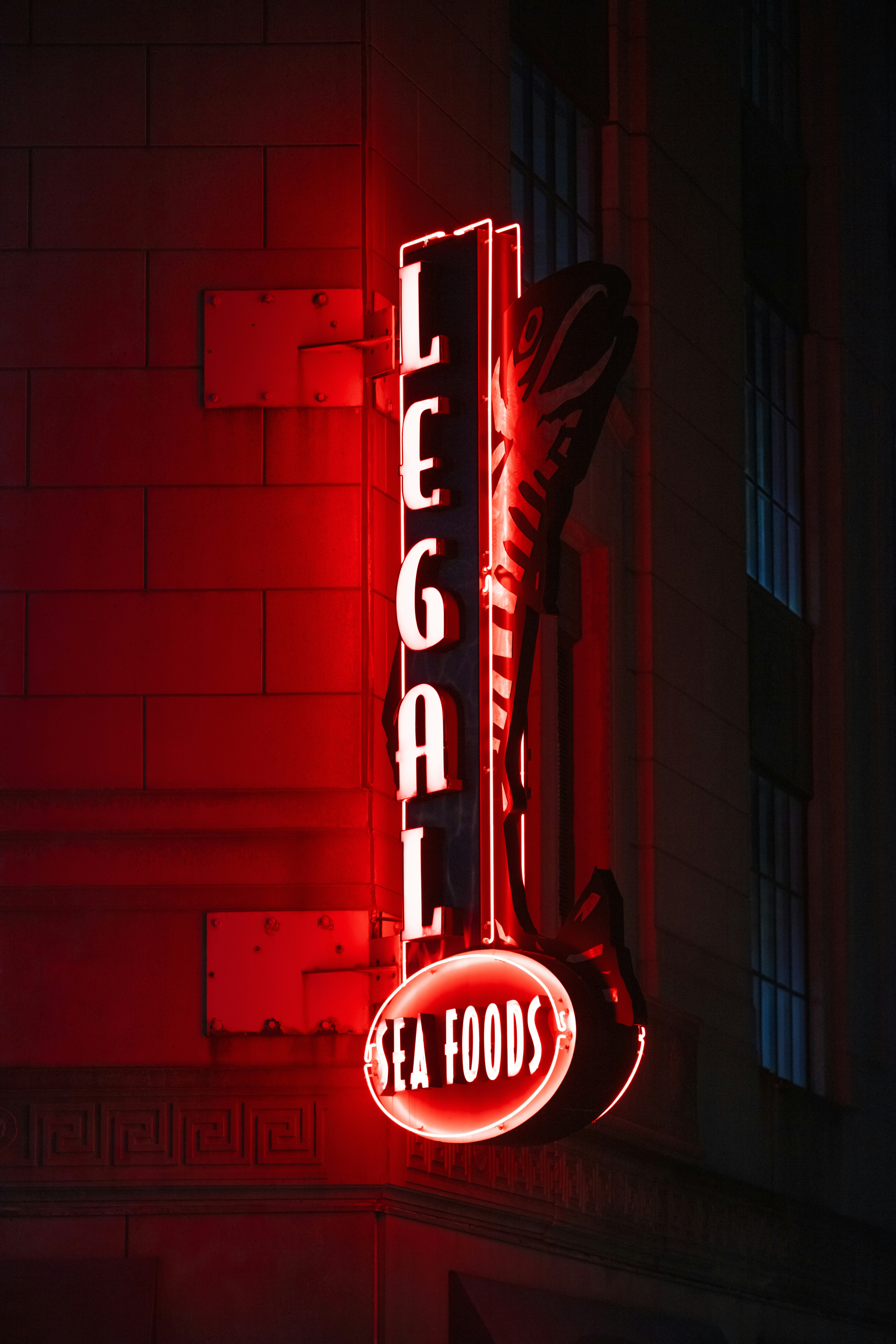 A neon sign on the side of a building photo – Free Usa Image on Unsplash