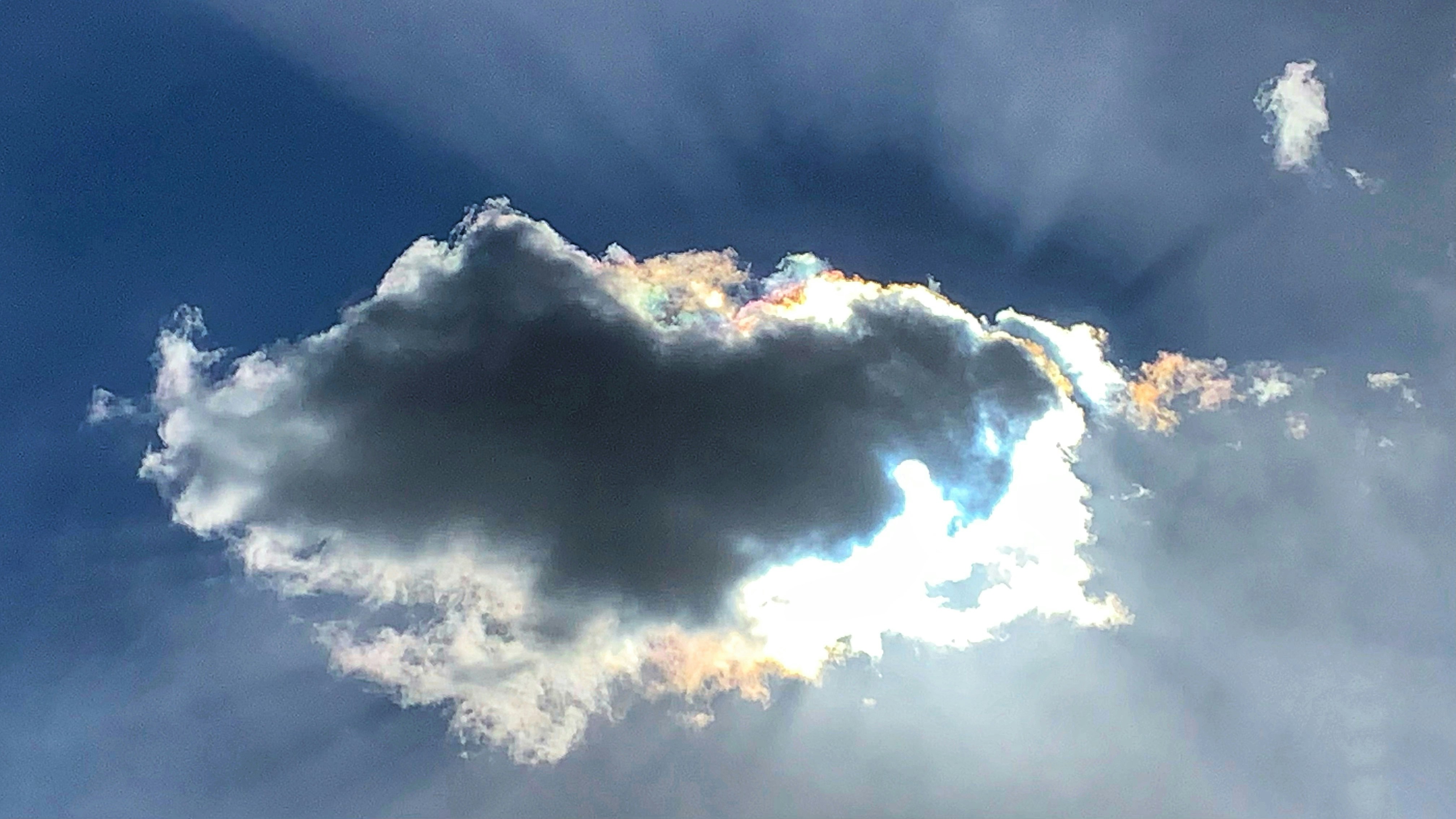 Iridescent Rim Over a Quiet Blue Sky