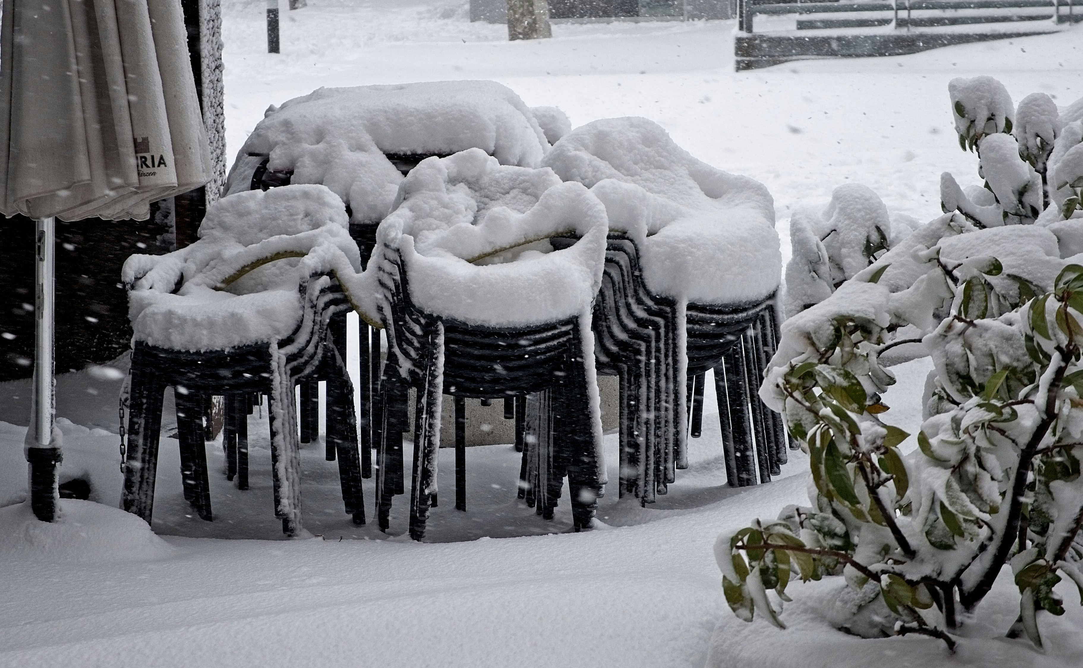 Snow-Laden Stacks: A Quiet Patio After the First Snowfall