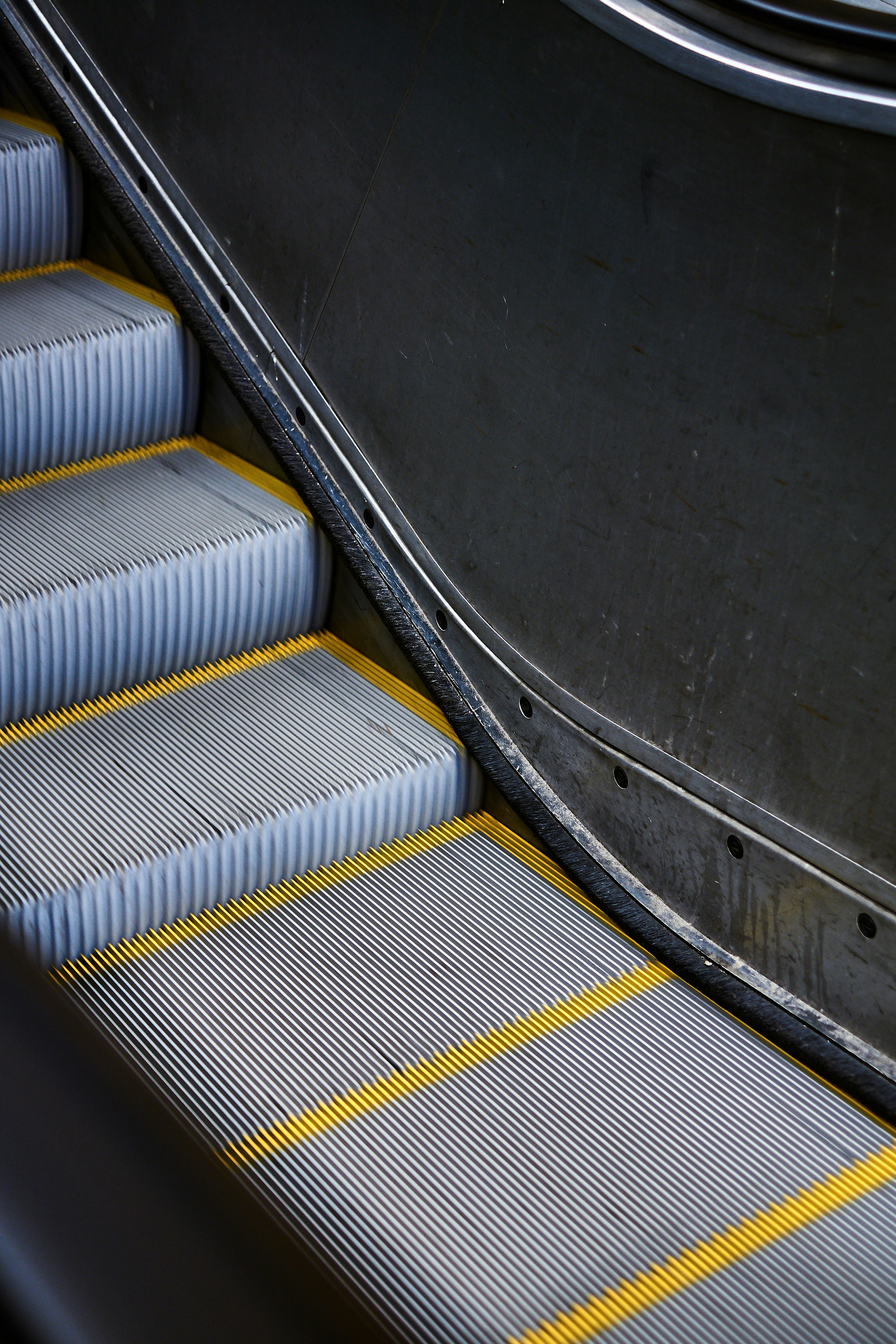 An escalator with blue and yellow striped steps photo – Free Stockholm ...