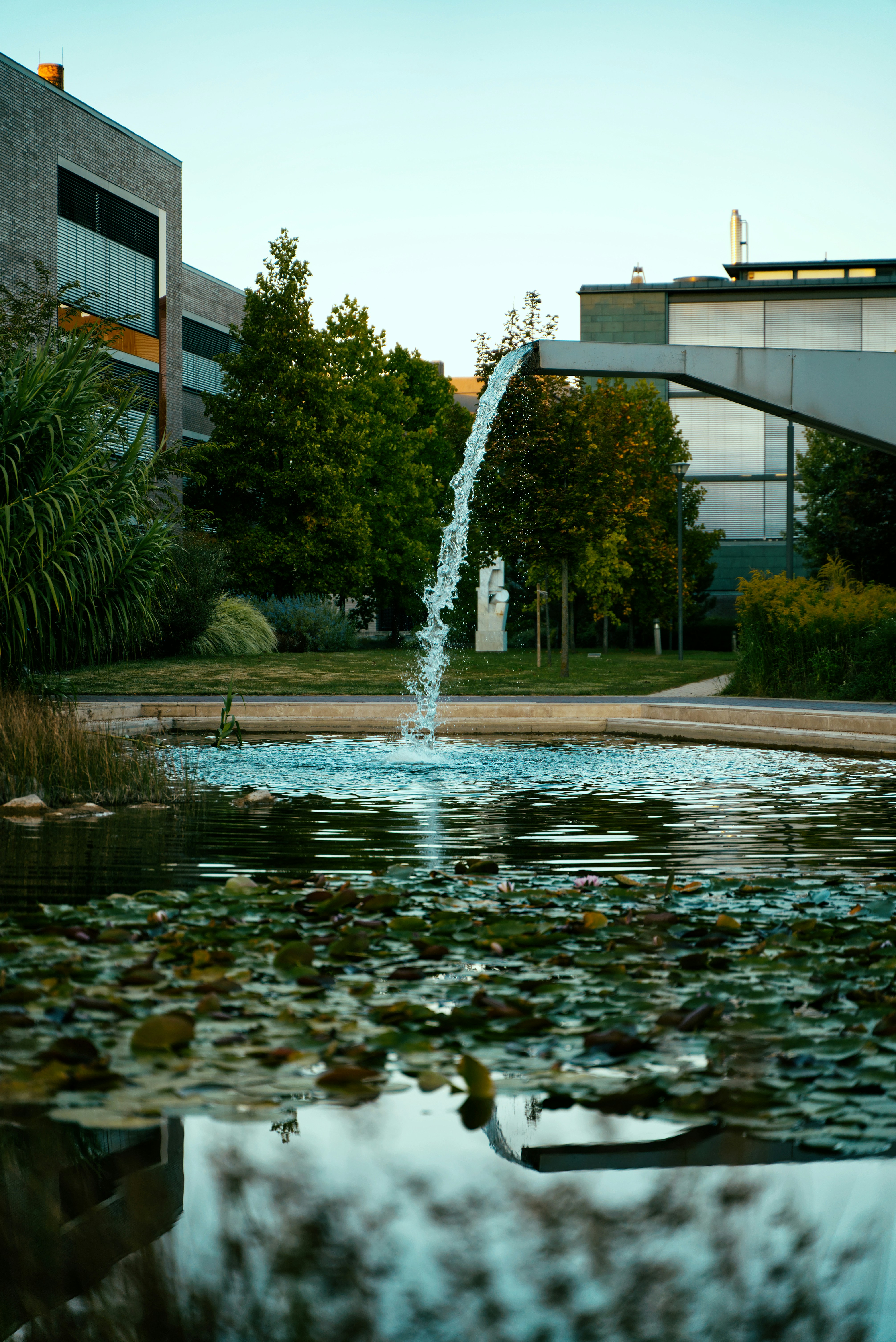 A water fountain spewing out water into a pond photo – Free Budapest ...