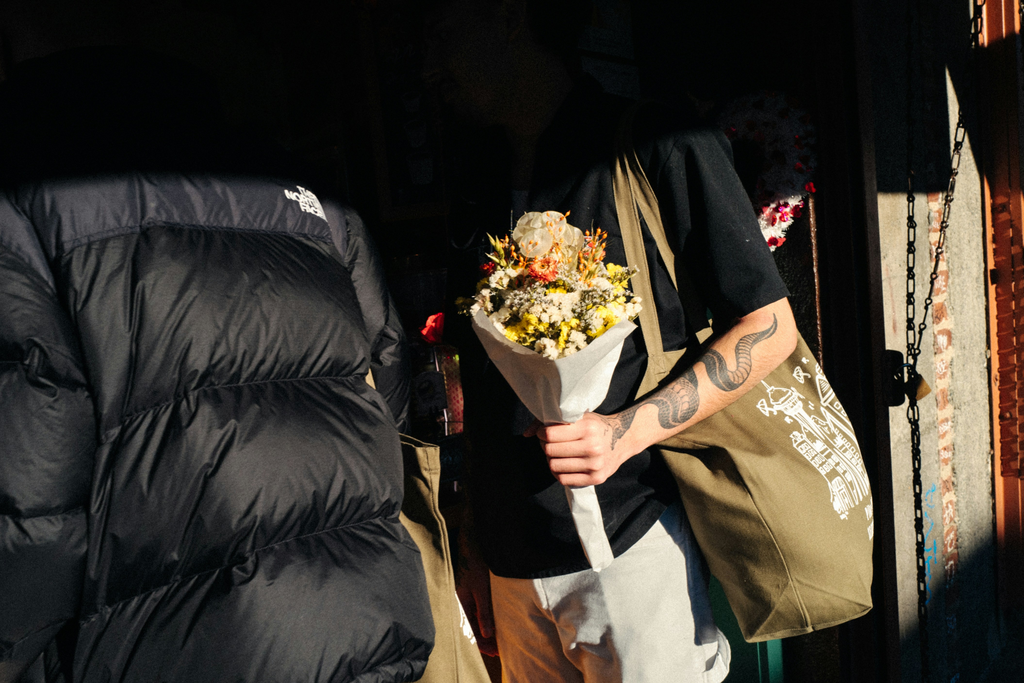 Bouquet at the Threshold: Color Amid Shadowed Doorway