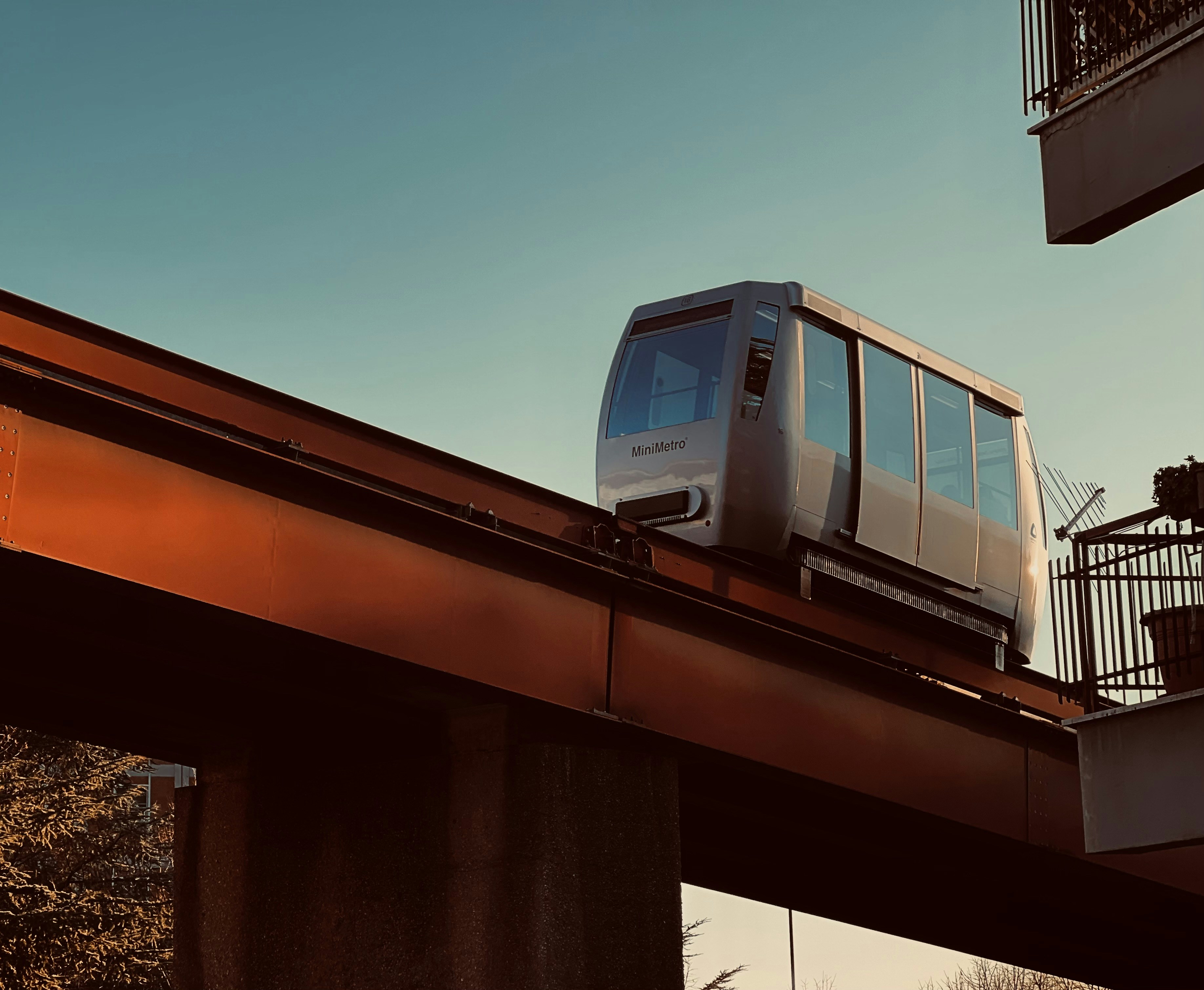 Above the Rails: A Train Glides Along a Rusty Span