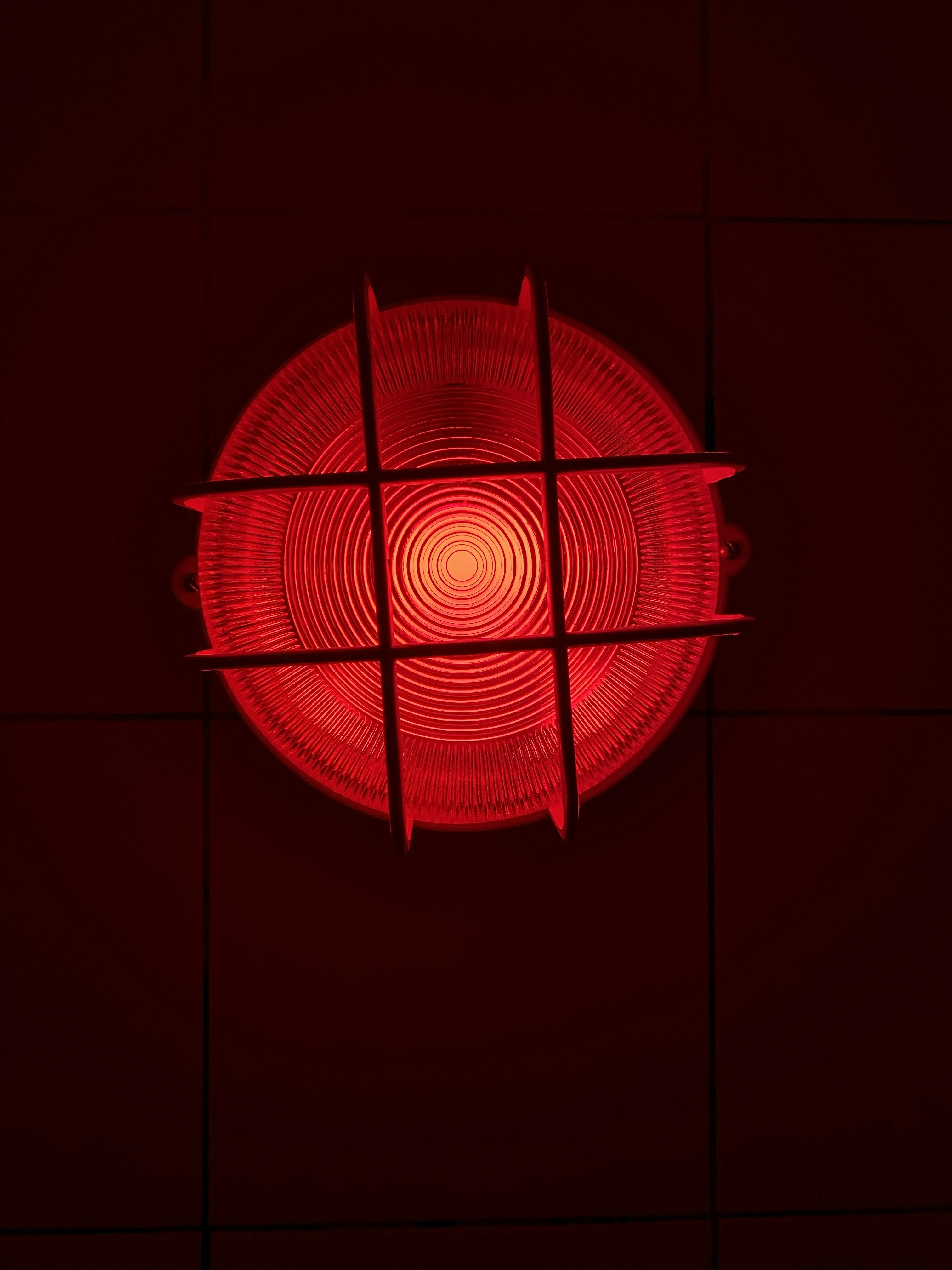 a red traffic light sitting on the side of a building