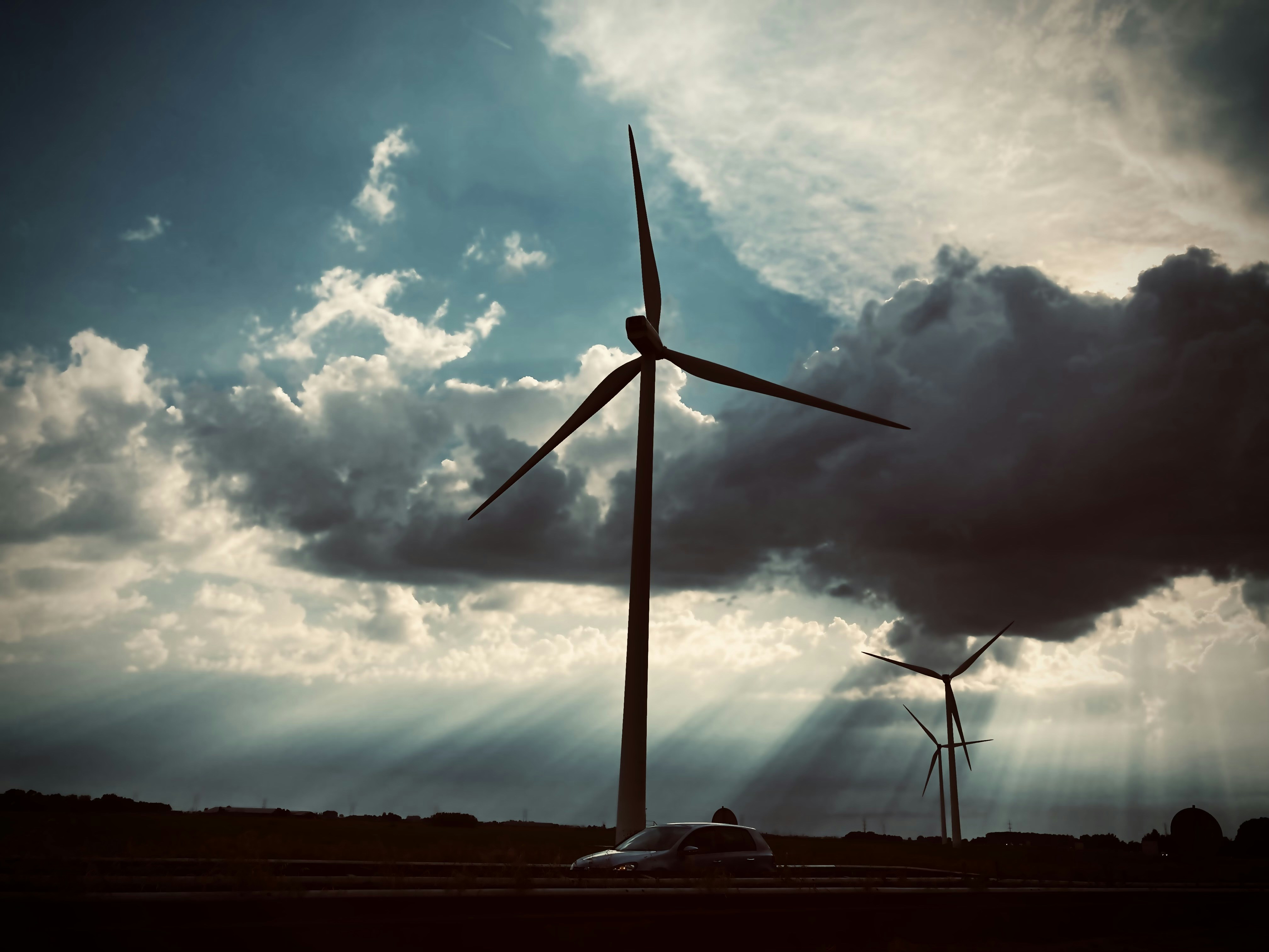 Whispers of the Wind: A Dance of Turbines and Clouds