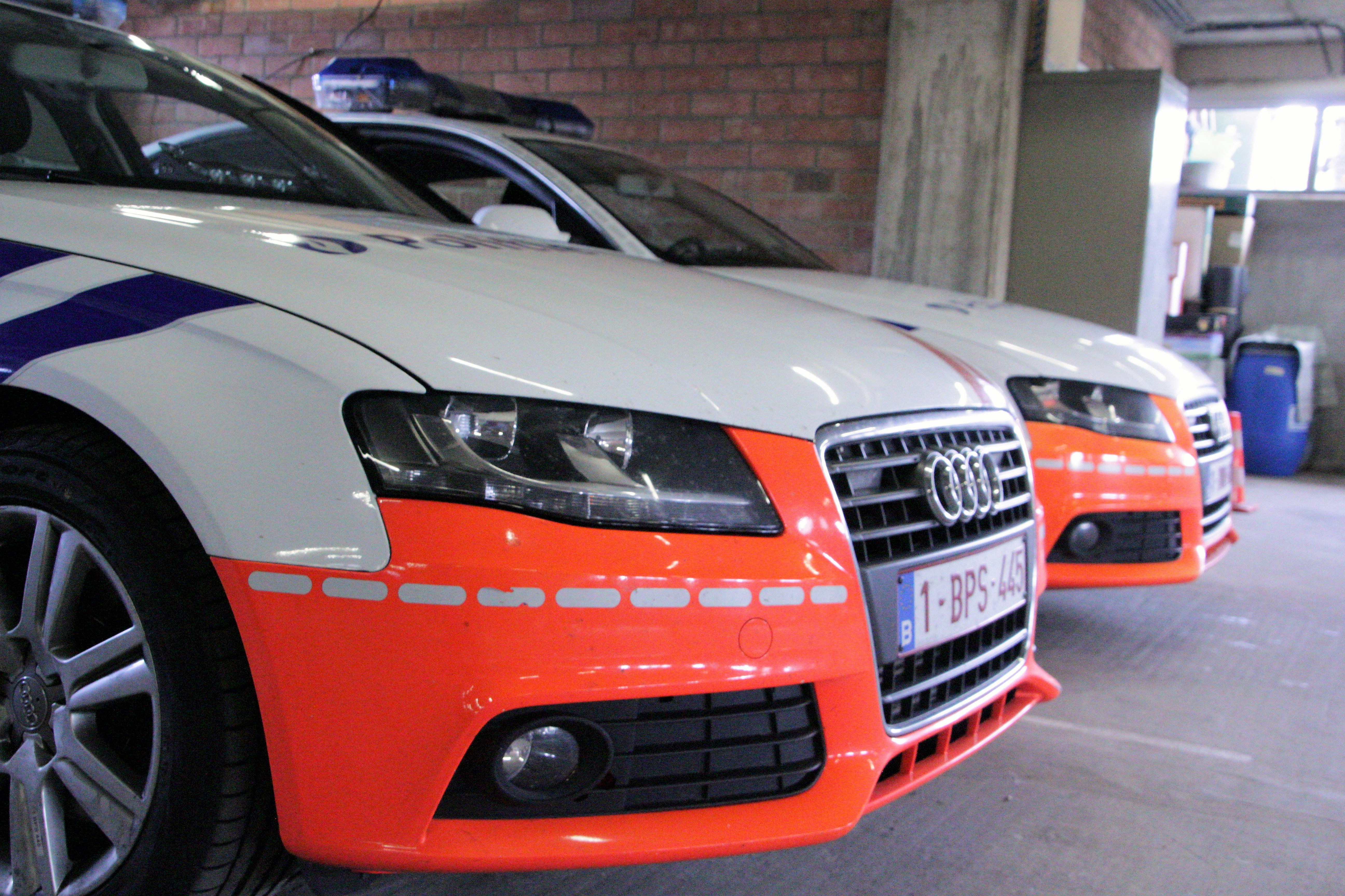 Two police cars parked in a parking garage photo – Free België Image on ...