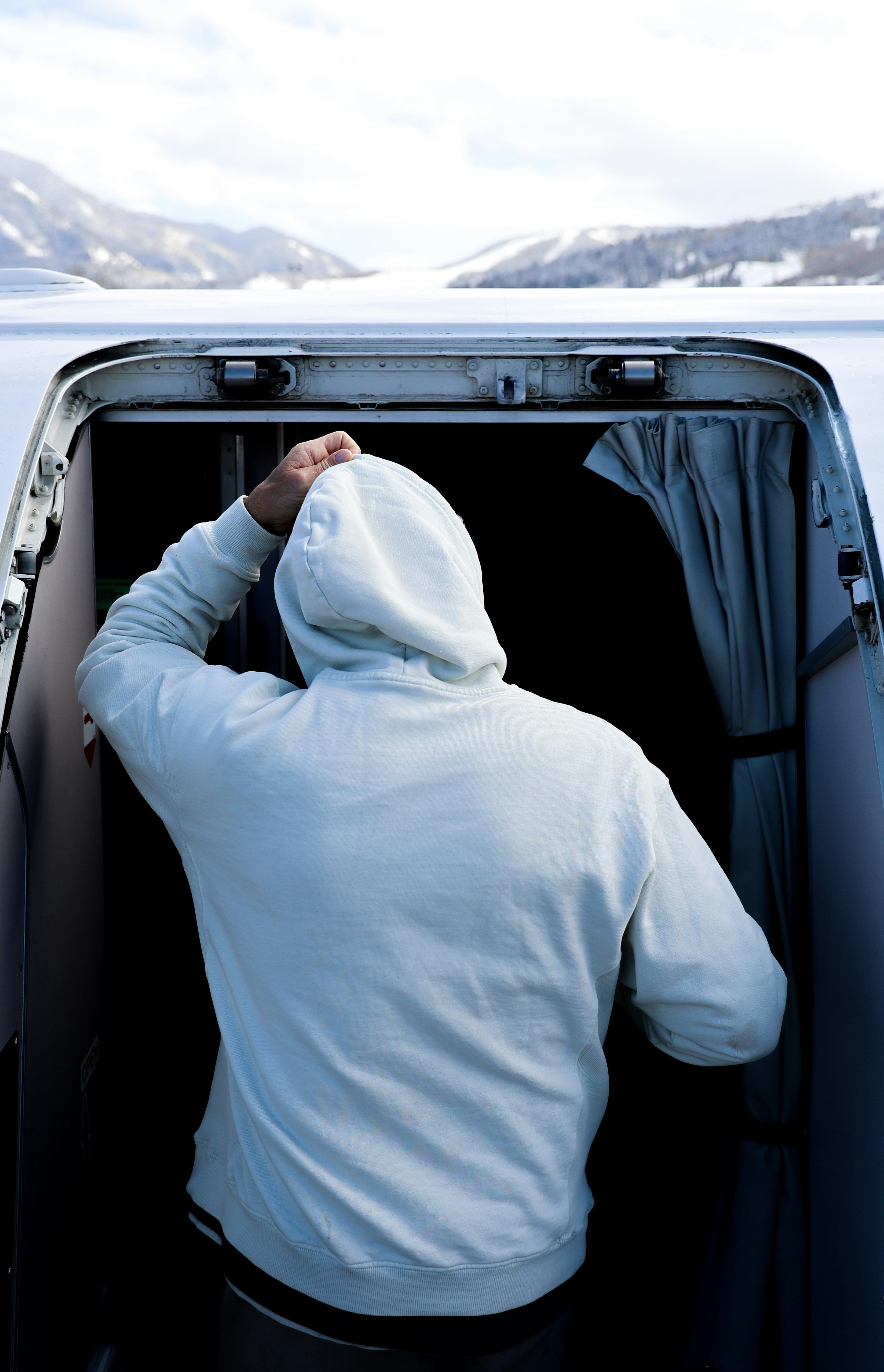 Hooded Exit at the Frostline: Entering a Snowbound Van
