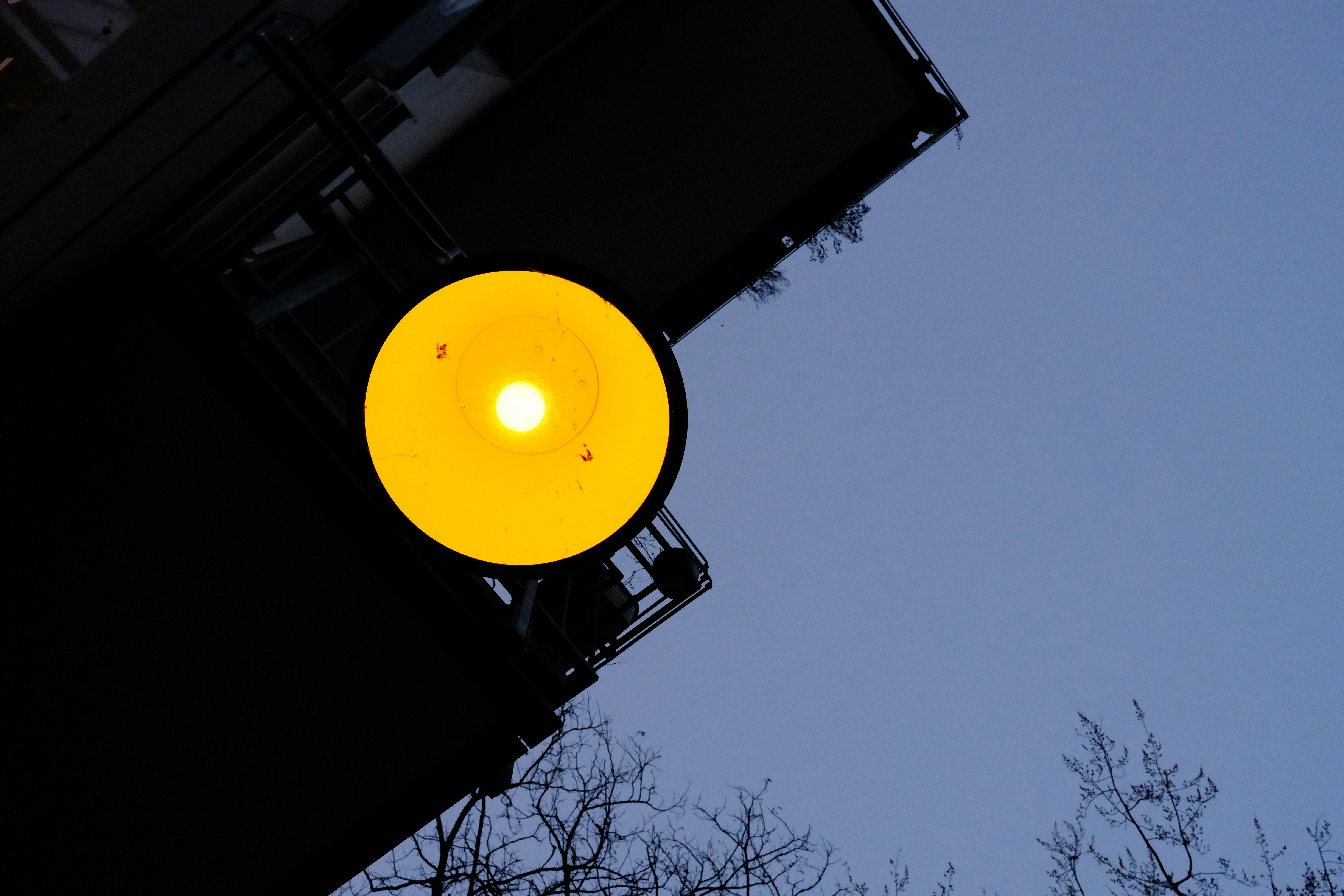 Amber Orb Against a Velvet Blue: A Minimalist Streetlamp Portrait