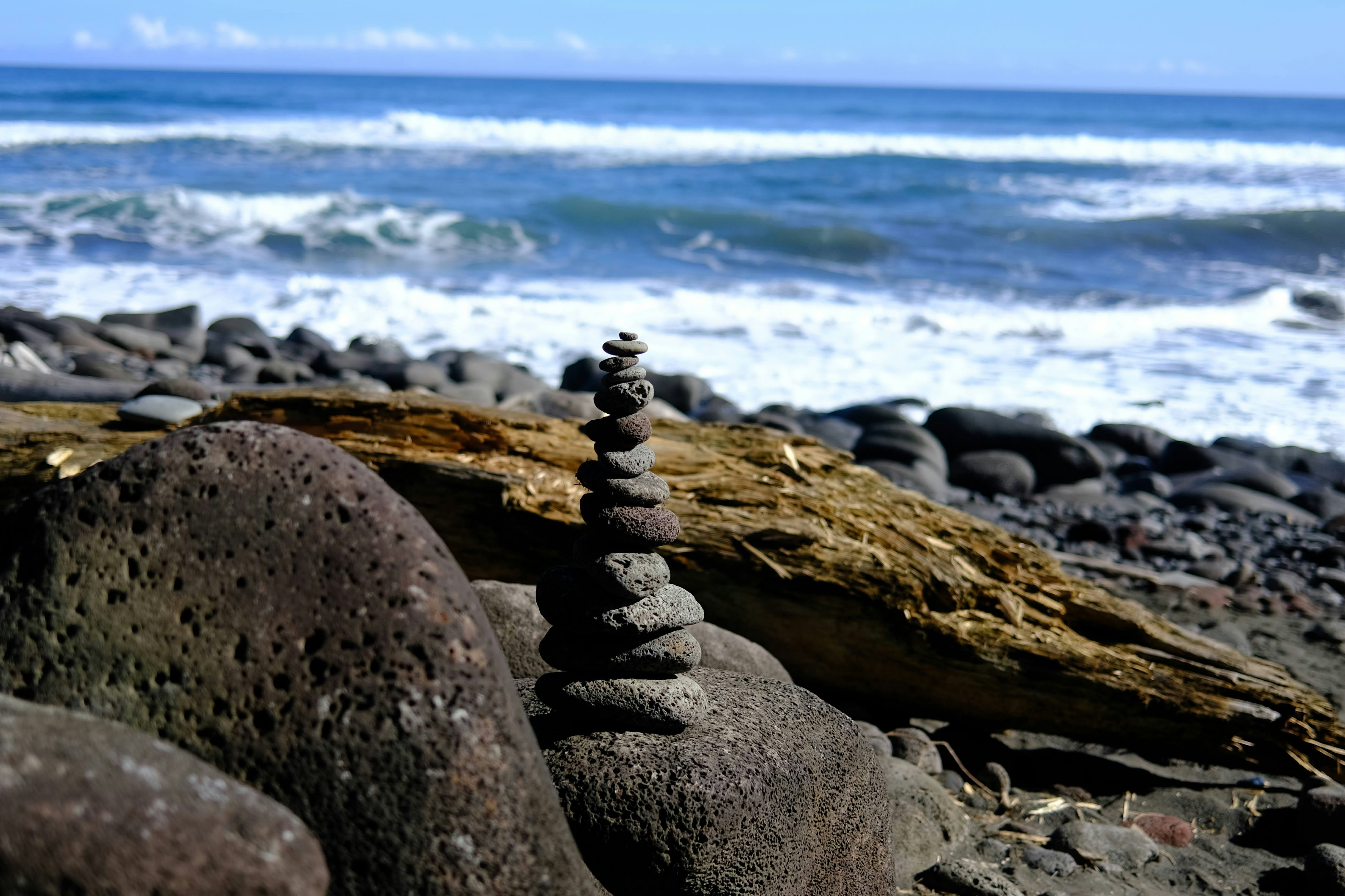 A stack of rocks sitting on top of a beach photo – Free Usa Image on ...