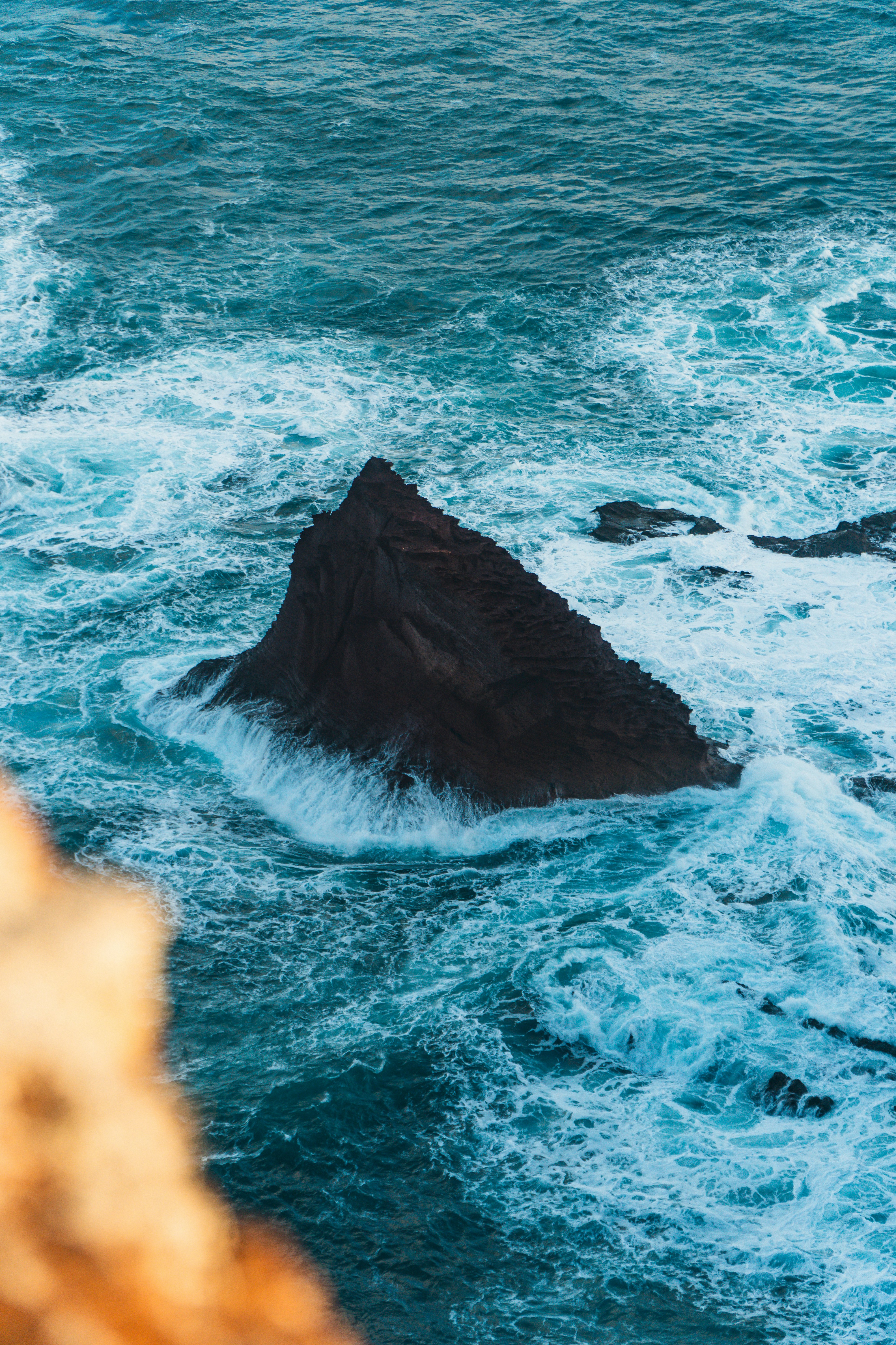 A large rock sticking out of the ocean photo – Free Portugal Image on ...