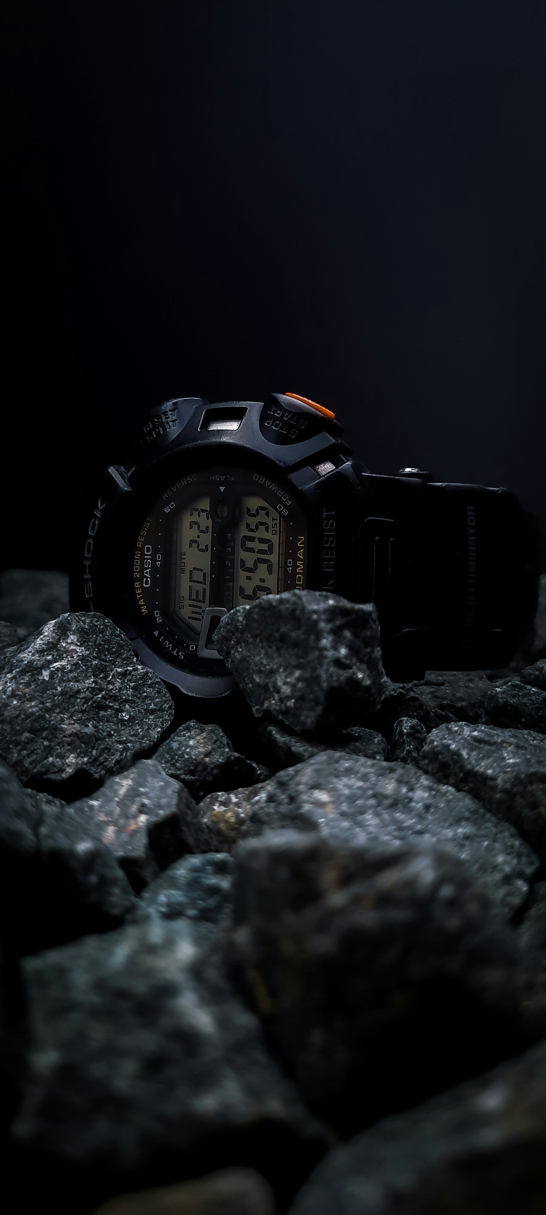 A watch sitting on top of a pile of rocks photo – Free Wristwatch Image ...