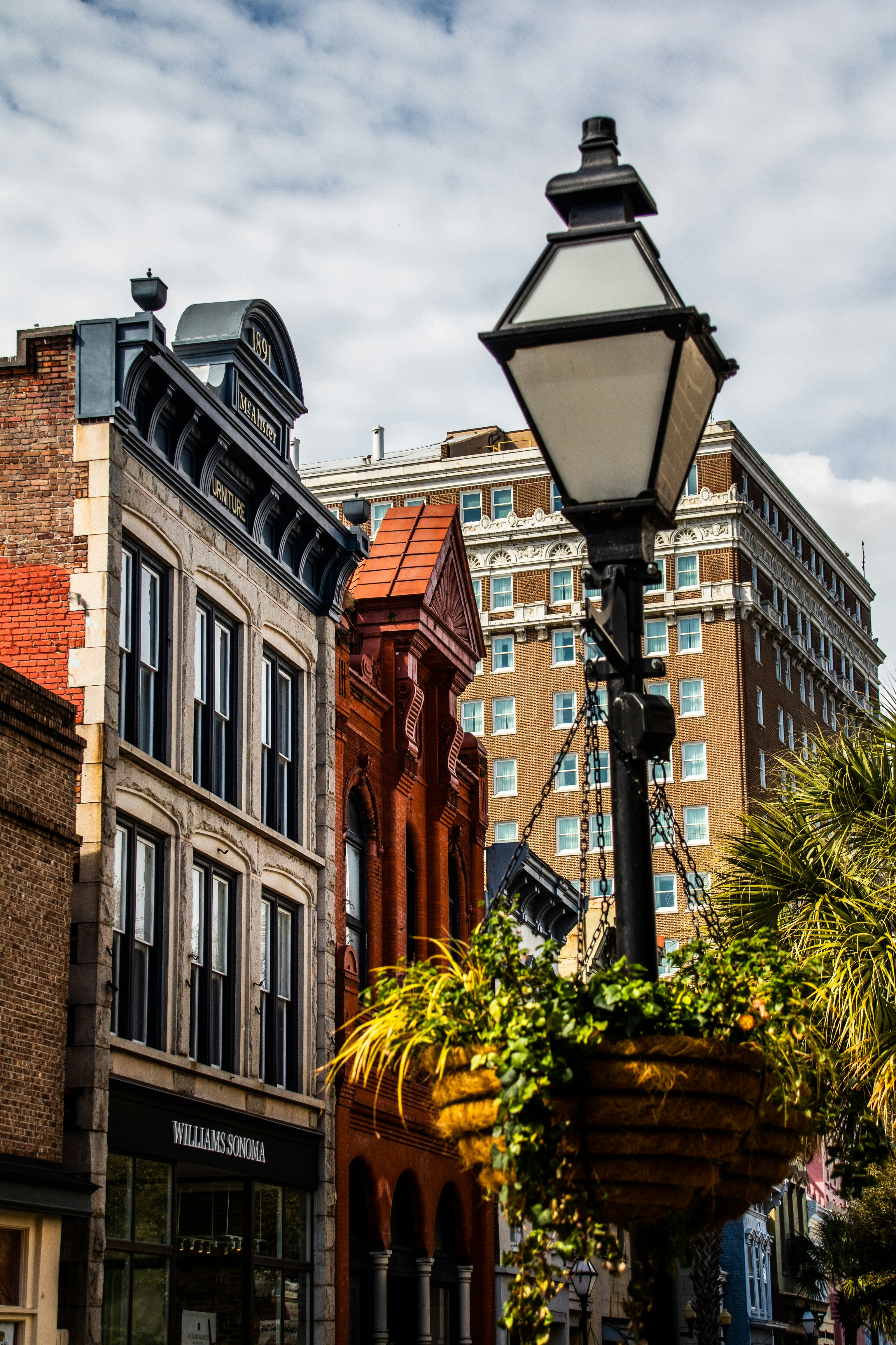A lamp post in the middle of a city street photo – Free Charleston ...