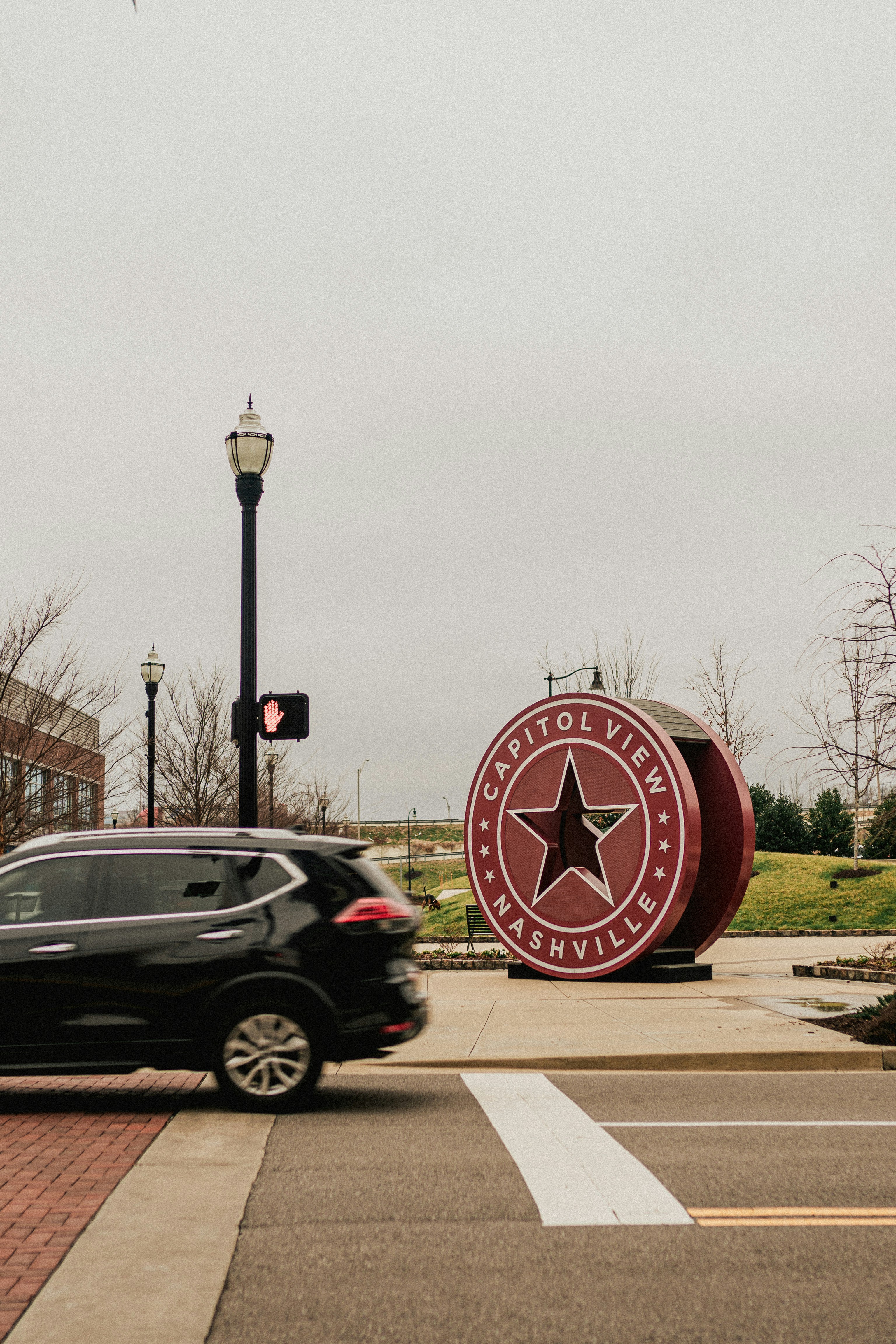 A black car driving past a red star sign photo – Free Nashville Image ...