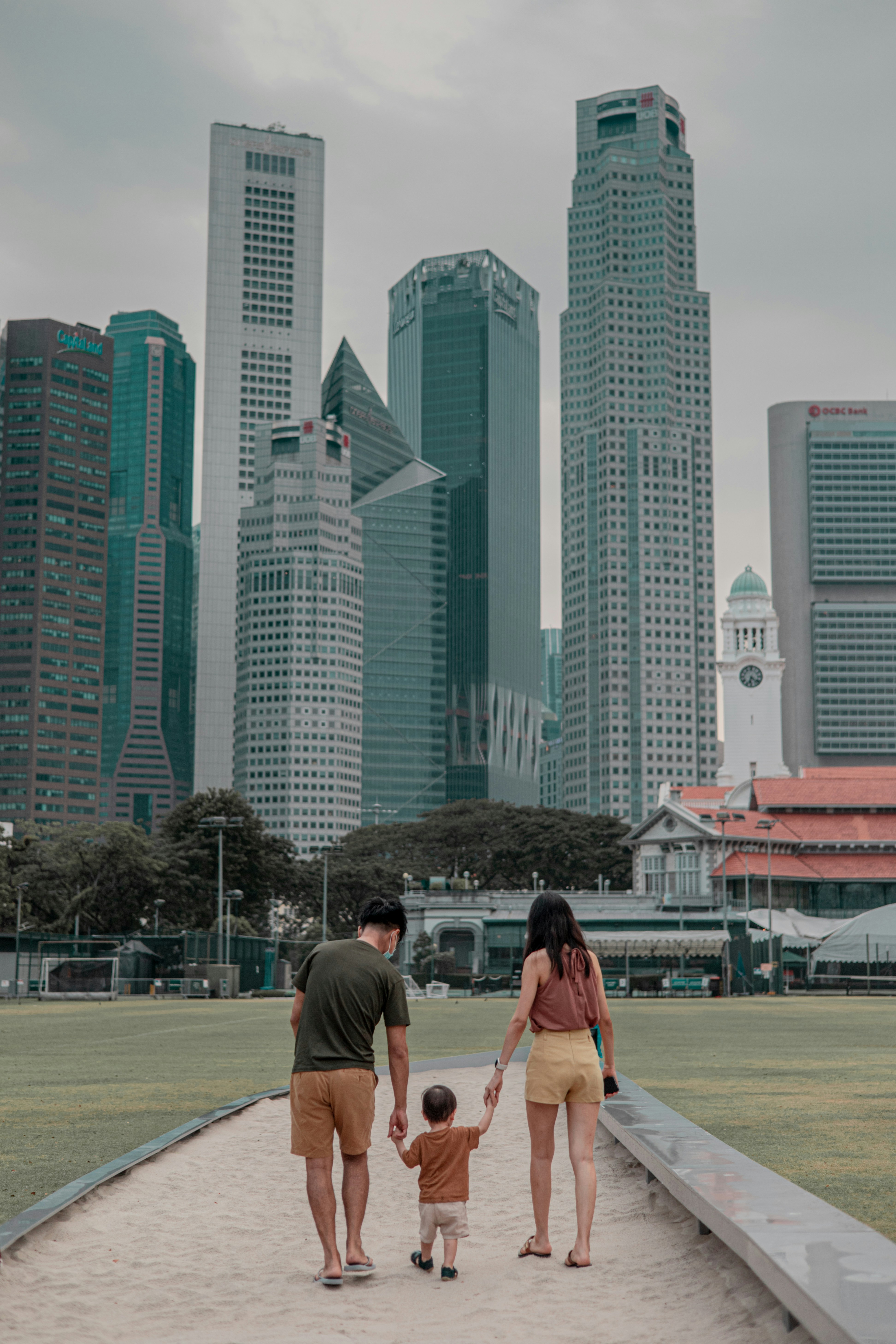 Cityscape and Family Stroll: A Moment Beneath Skyscrapers