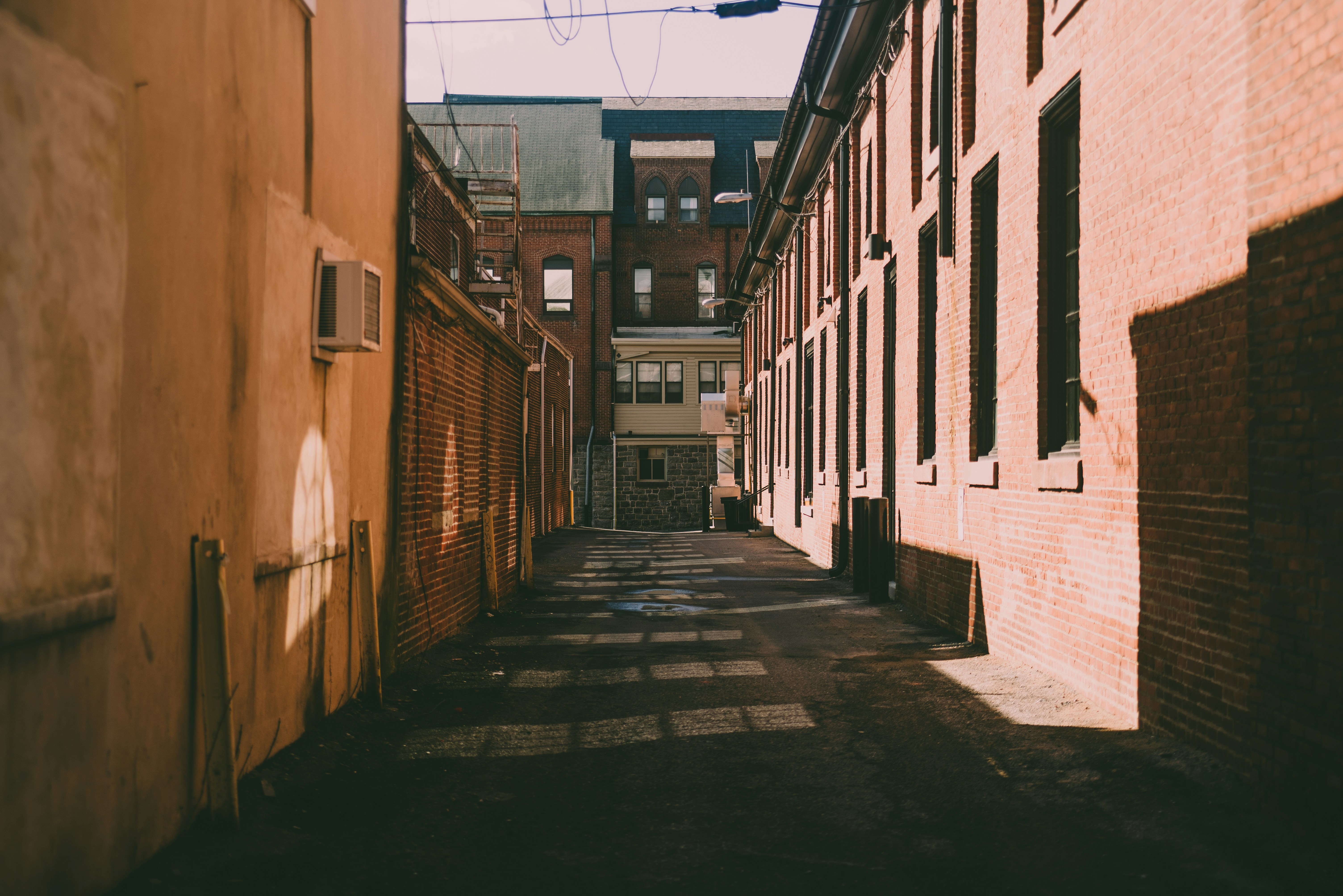 A narrow alley way between two buildings photo – Free Peaceful Image on ...