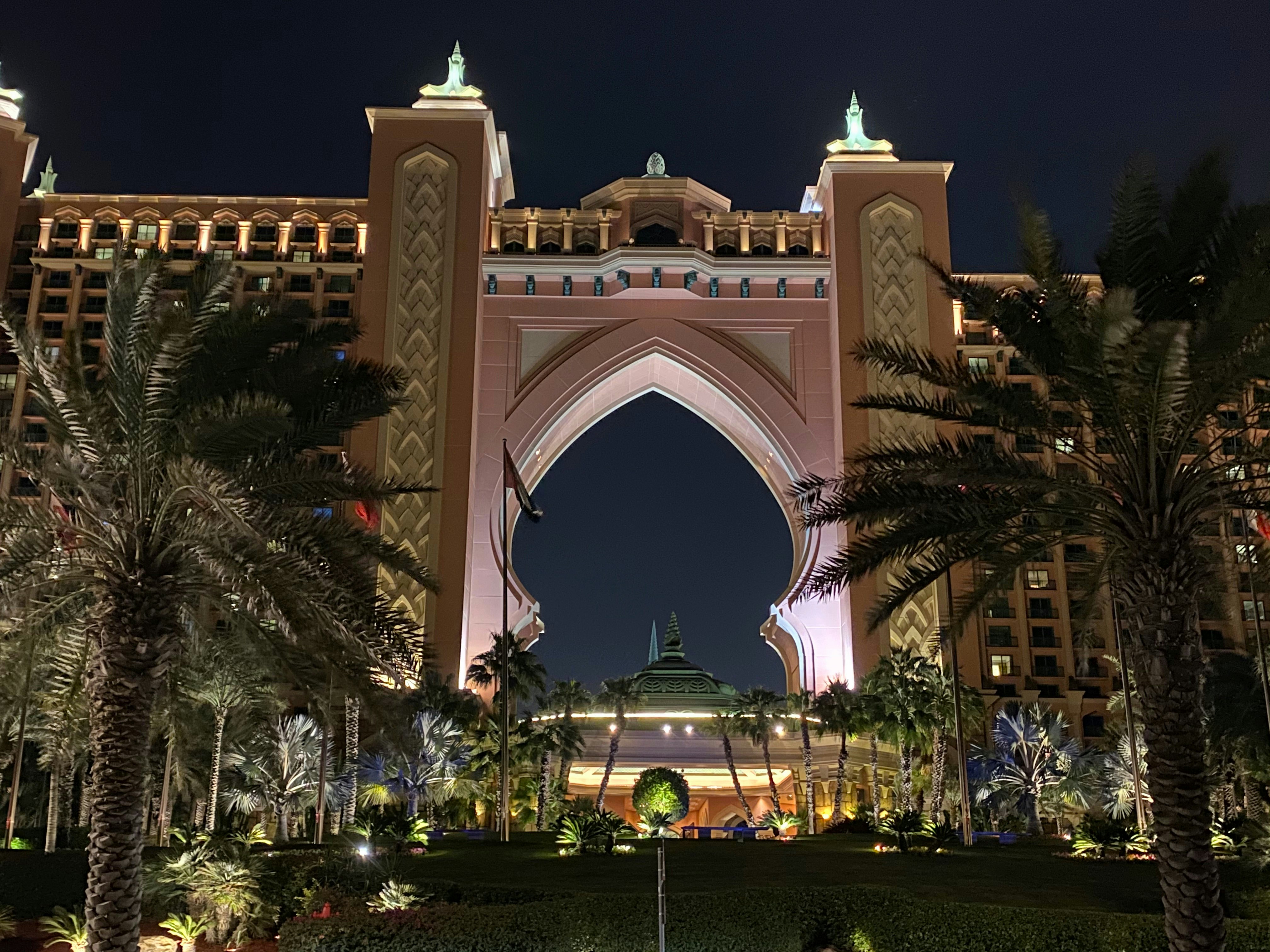 A very tall building with a massive arch in the middle of it photo ...