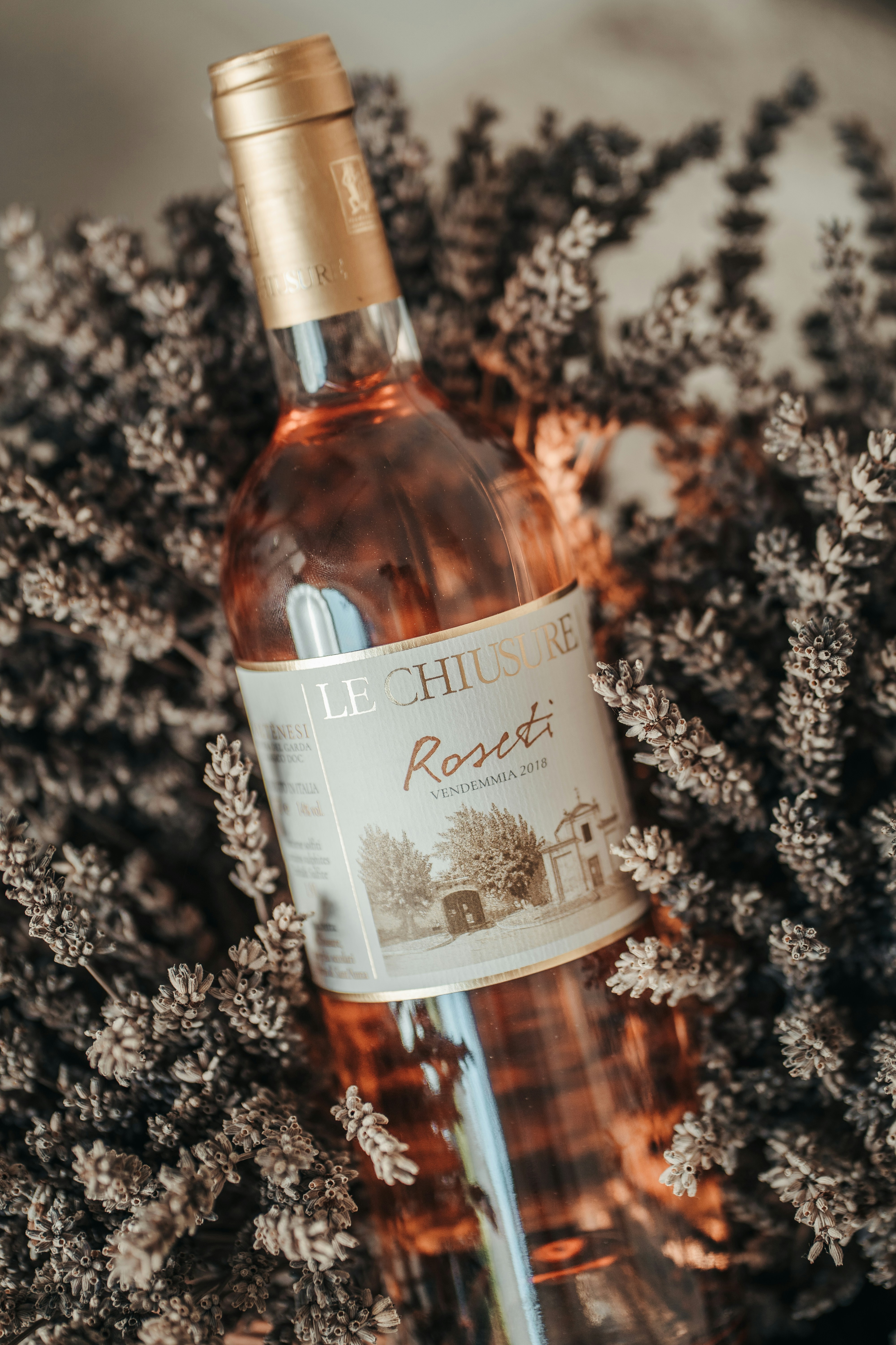 Roseate Stillness: A Bottled Rosé Among Lavender Haze