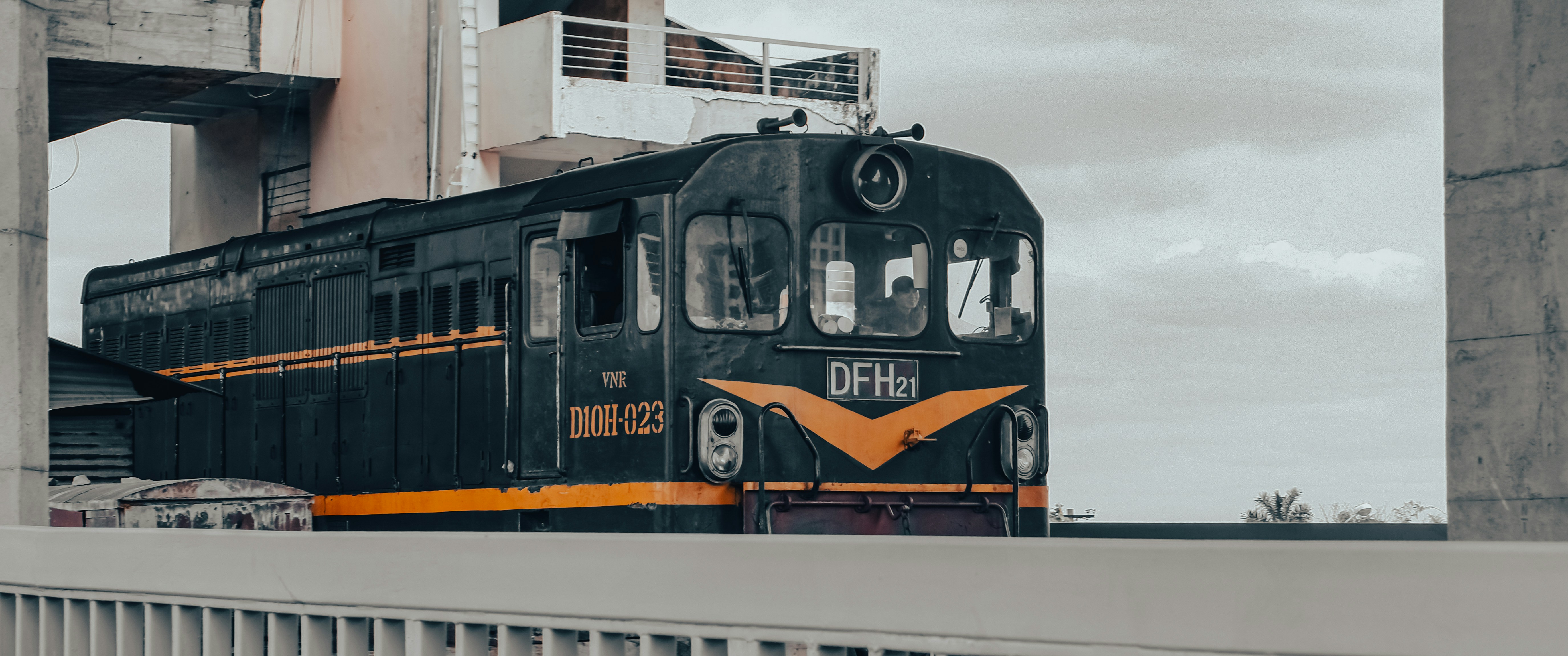Lead Engine on the Overpass: A Freight Diesel Glares Into the Urban Quiet