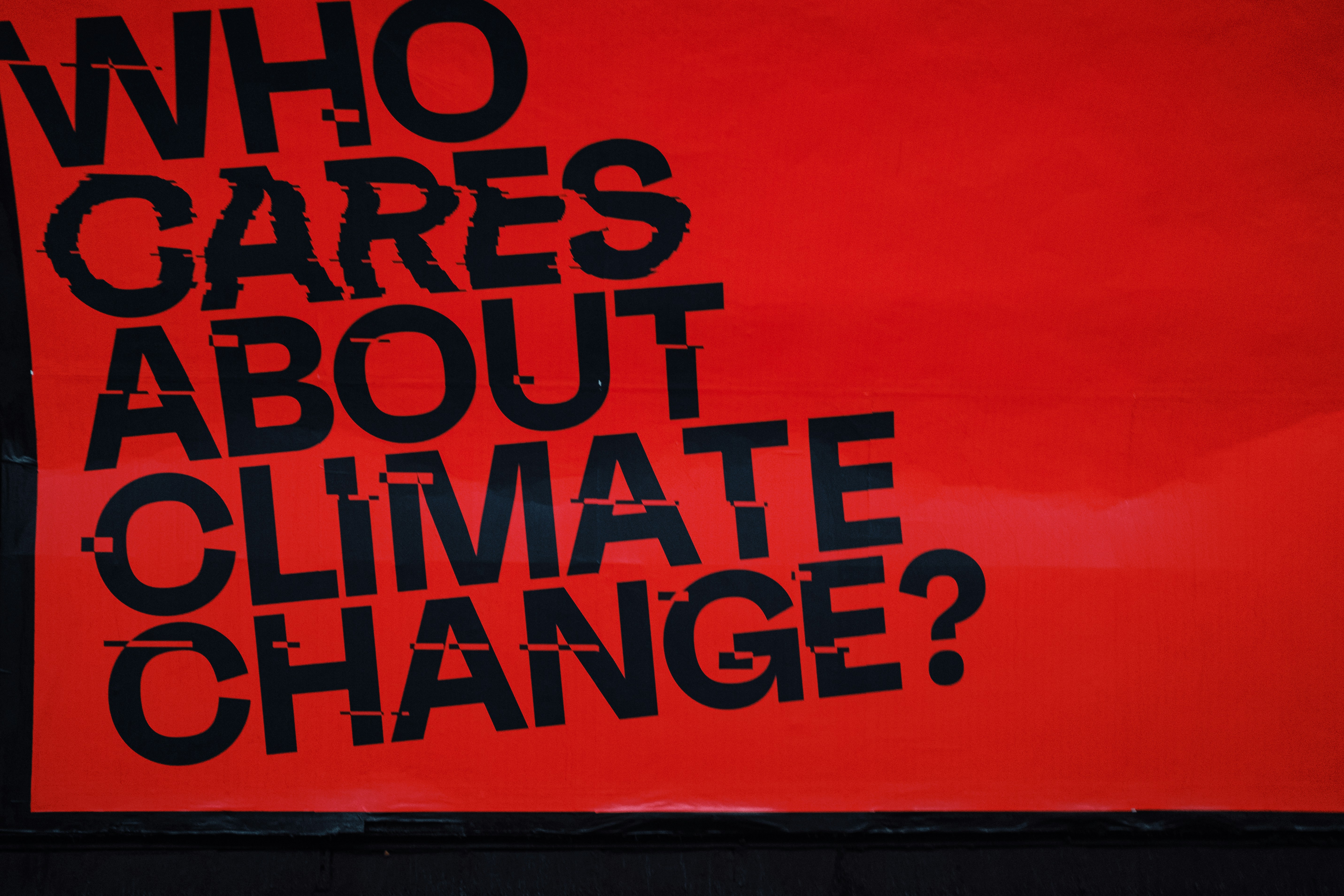 A red sign that says who cares about climate change? photo – Free ...