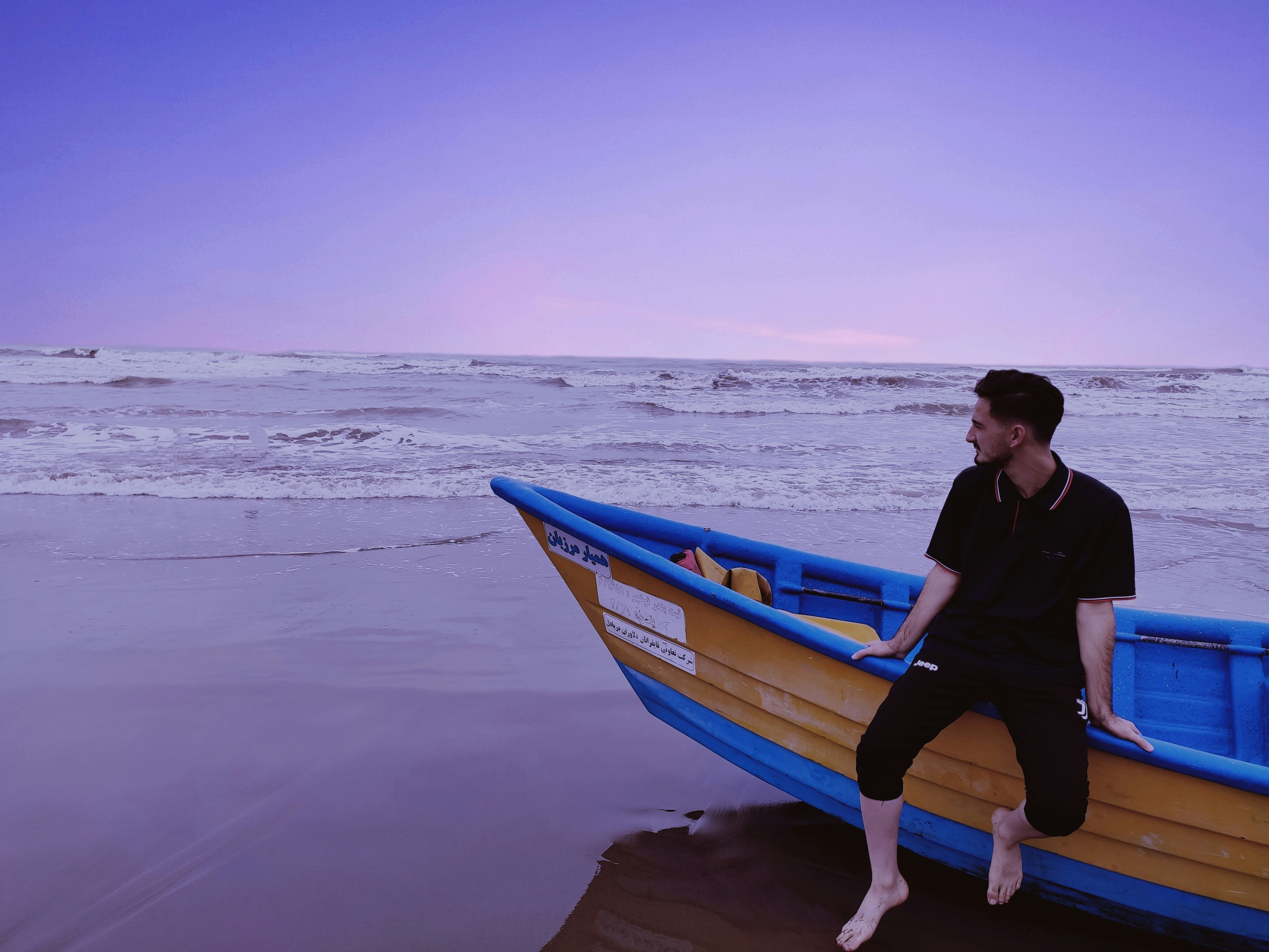 Blue Boat, Quiet Sea, and a Pensive Figure