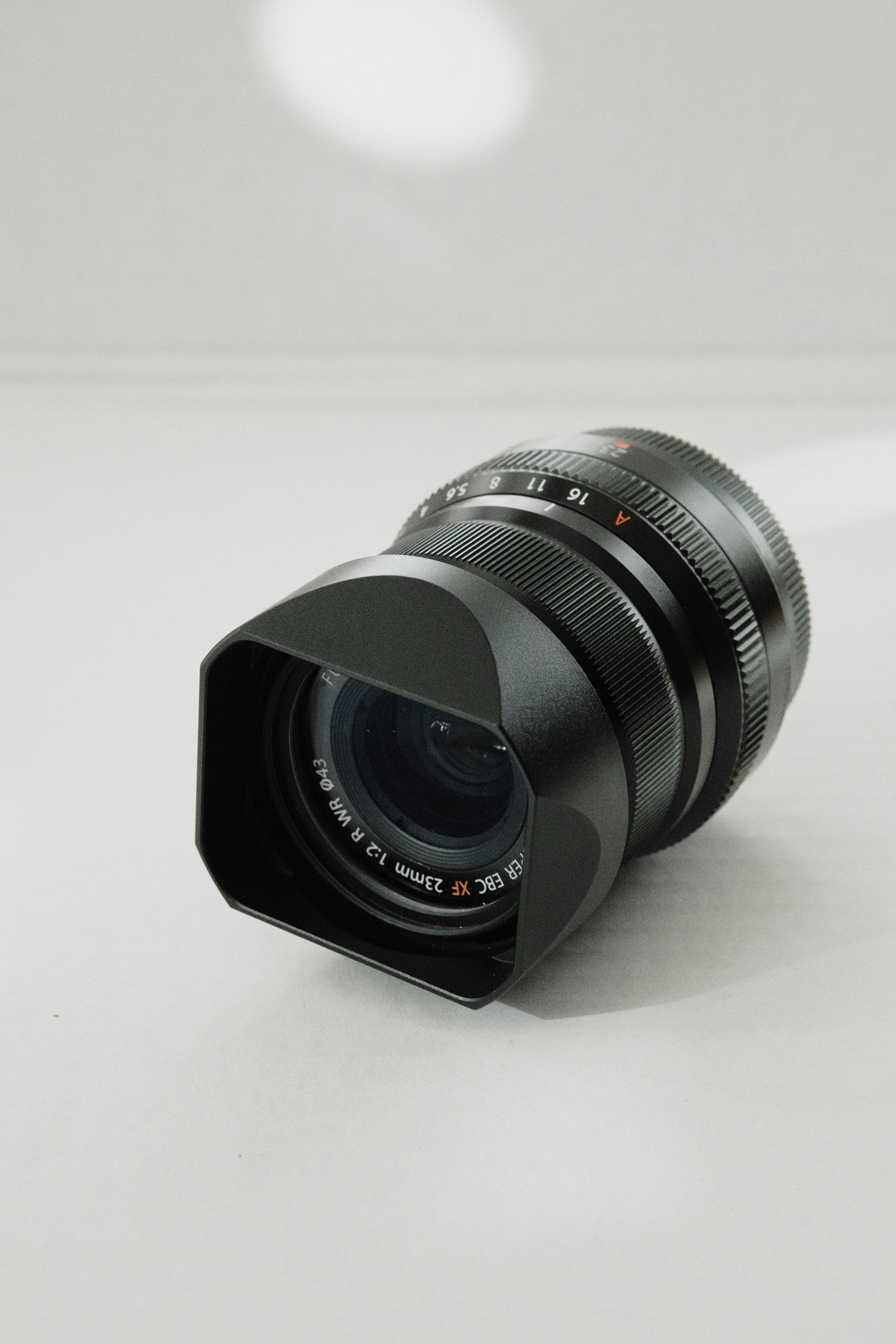 A close up of a camera lens on a white surface photo – Free Product ...