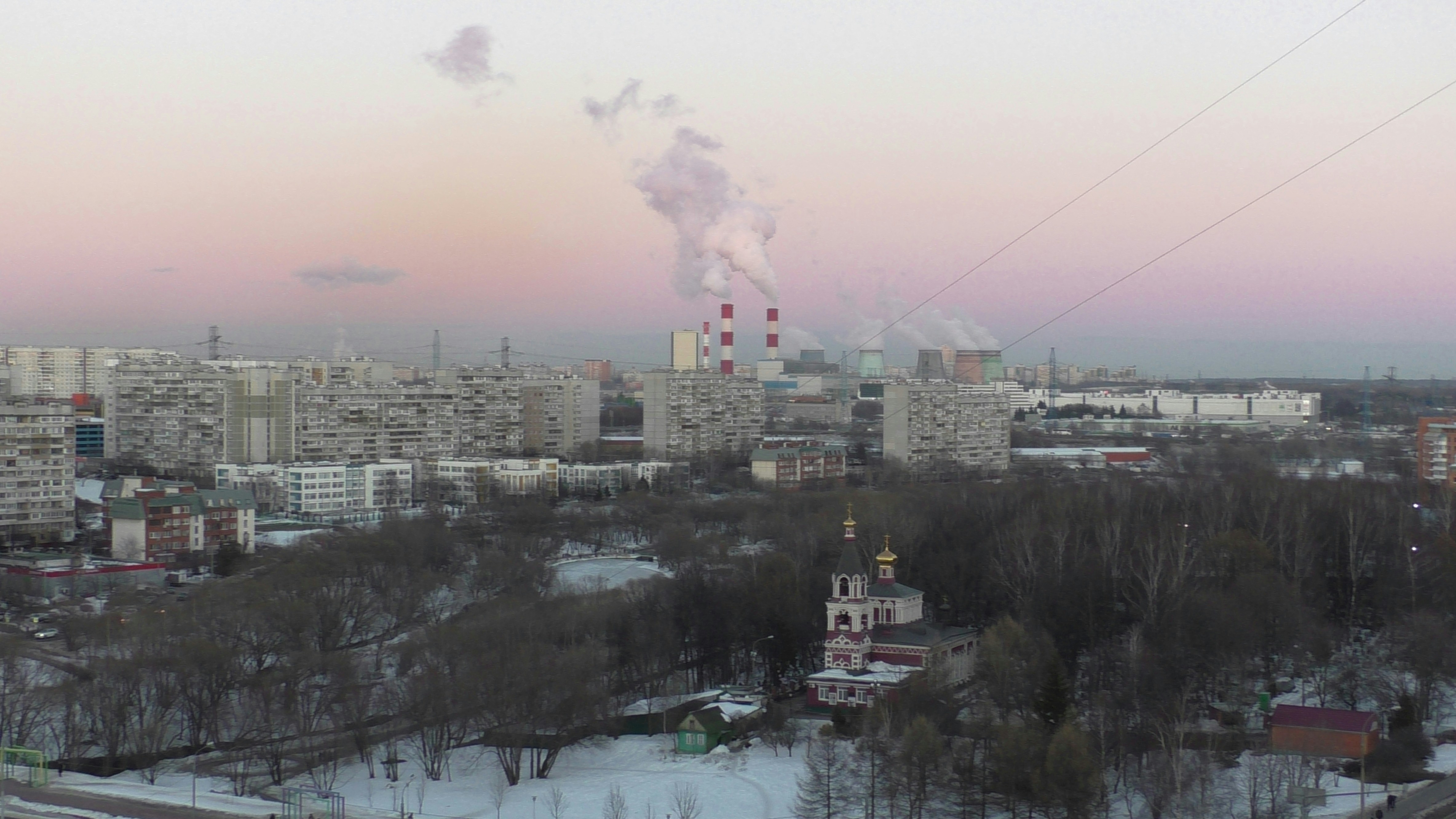 Smokestacks and twilight across a quiet industrial city