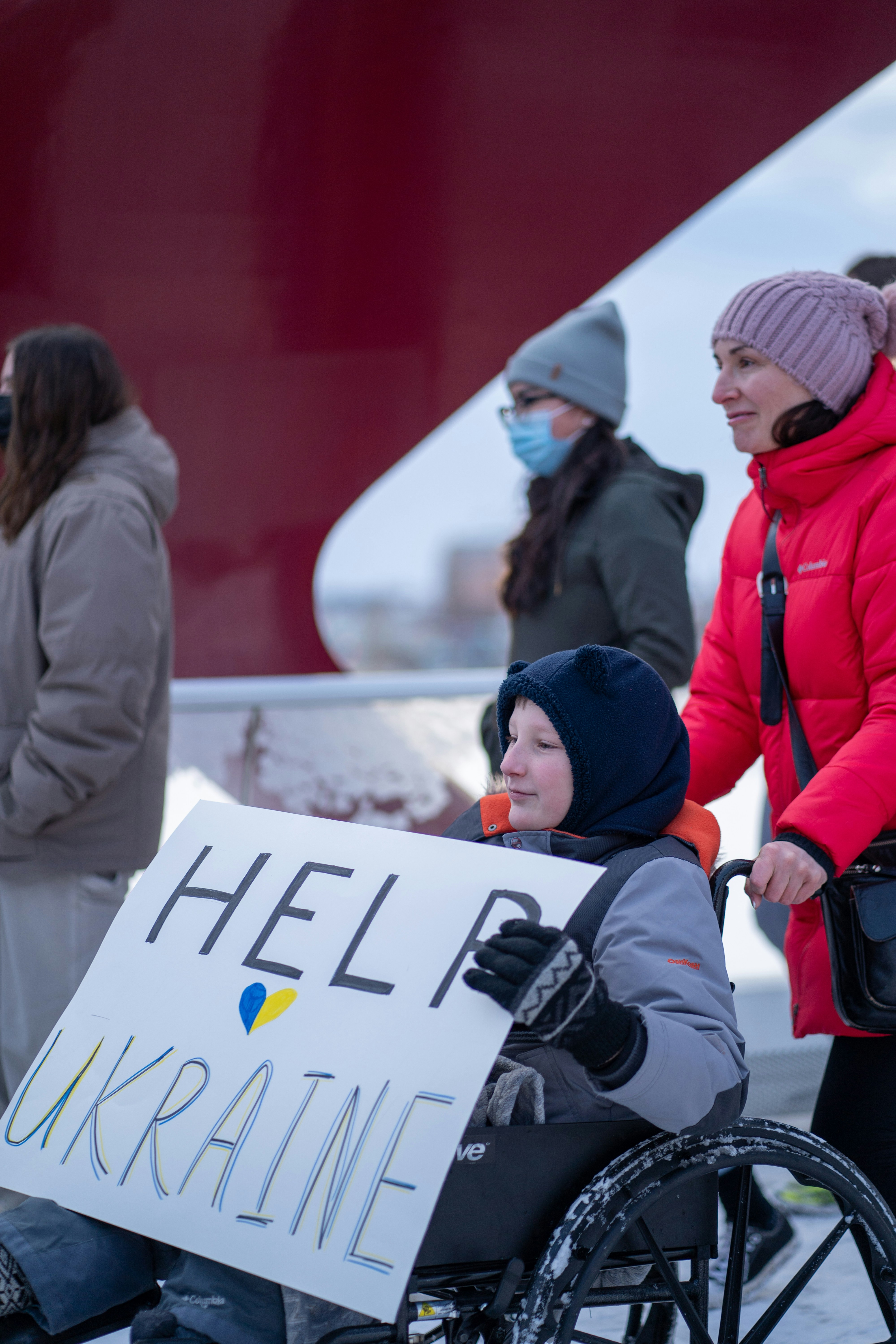 Winter Stand: A Young Person in a Wheelchair with a 'HELP UKRAINE' Sign